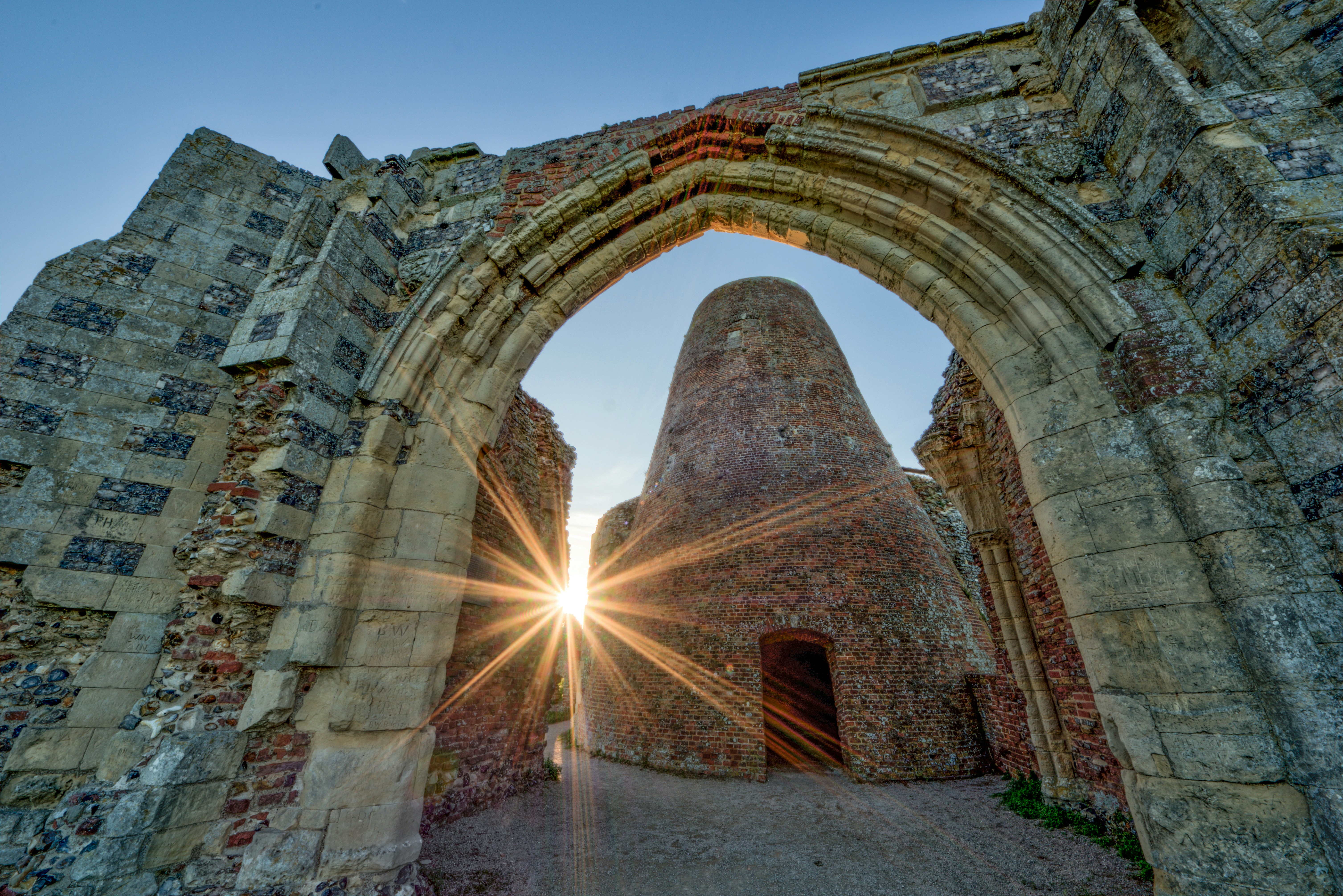 Sunburst Through a Stone Archway into a Tapered Tower