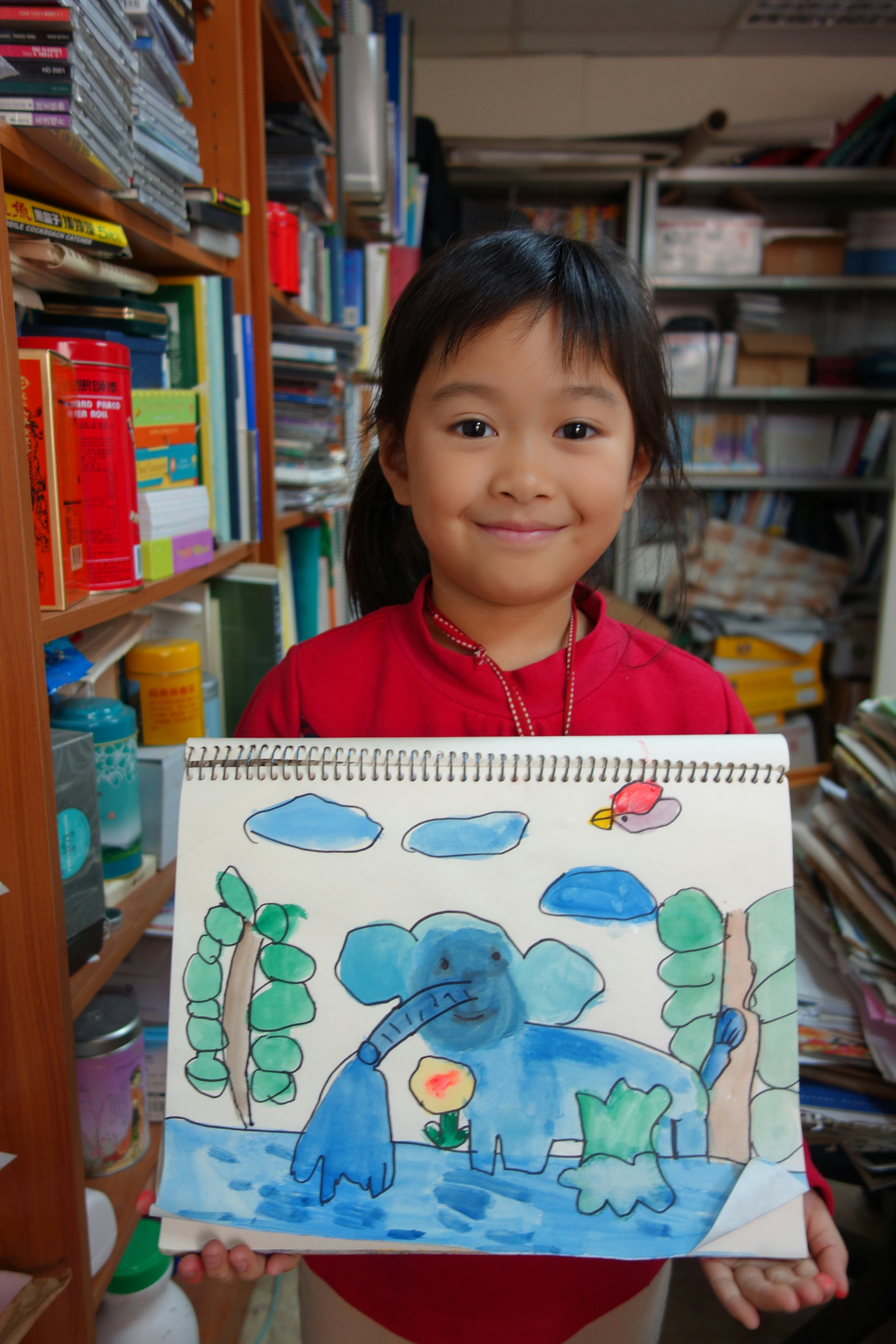 Little Artist with a Bright Smile and a Colorful Drawing
