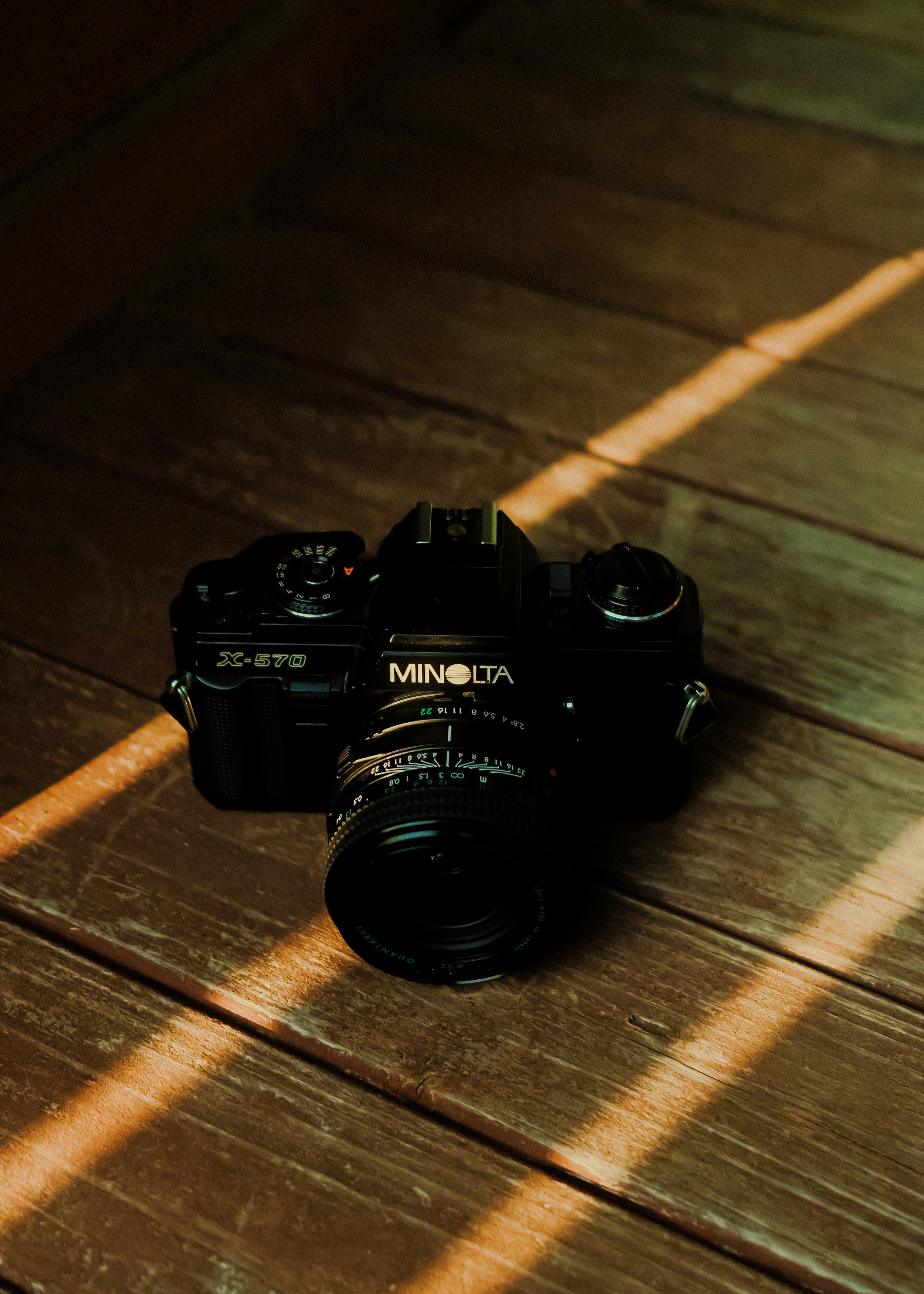 Shadowed Click: A Classic Minolta on a Wood Terrace