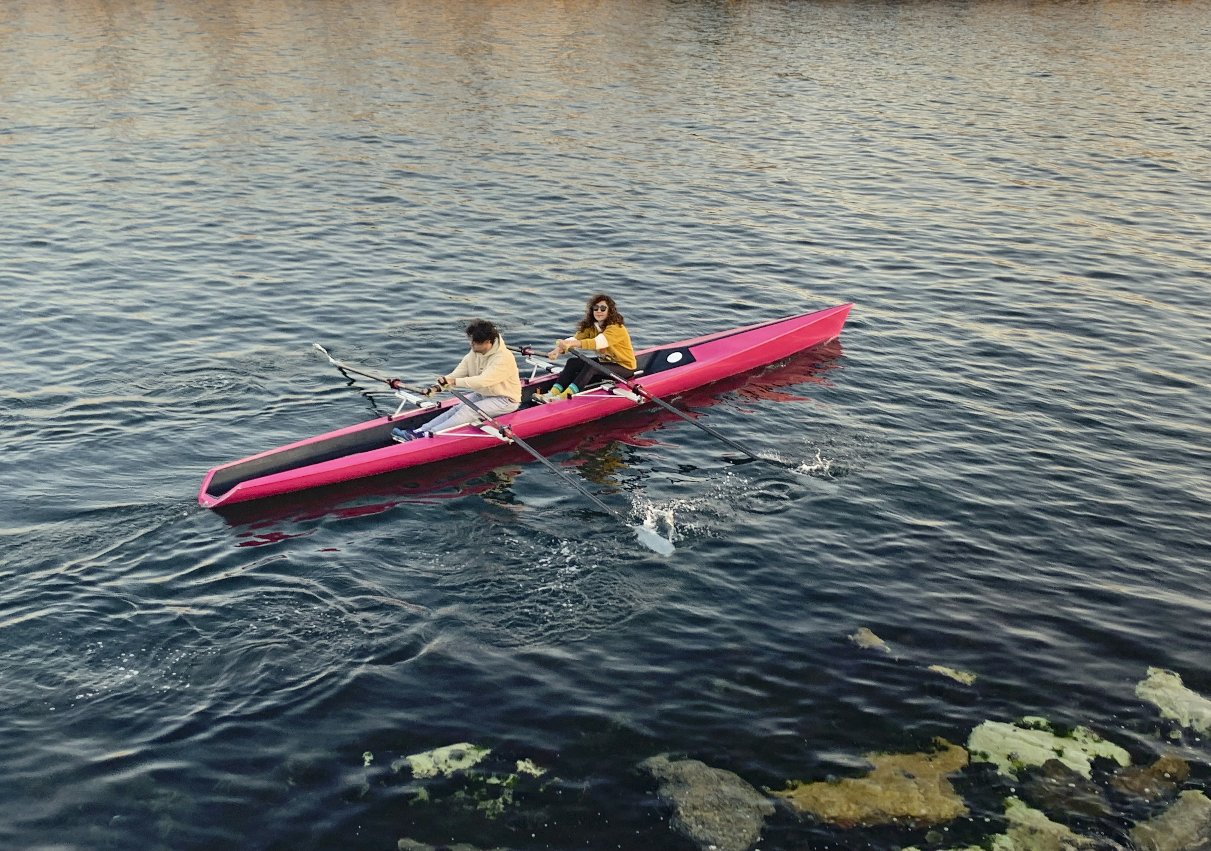 Pink Kayak Duo Cutting Through Calm Sunset Waters