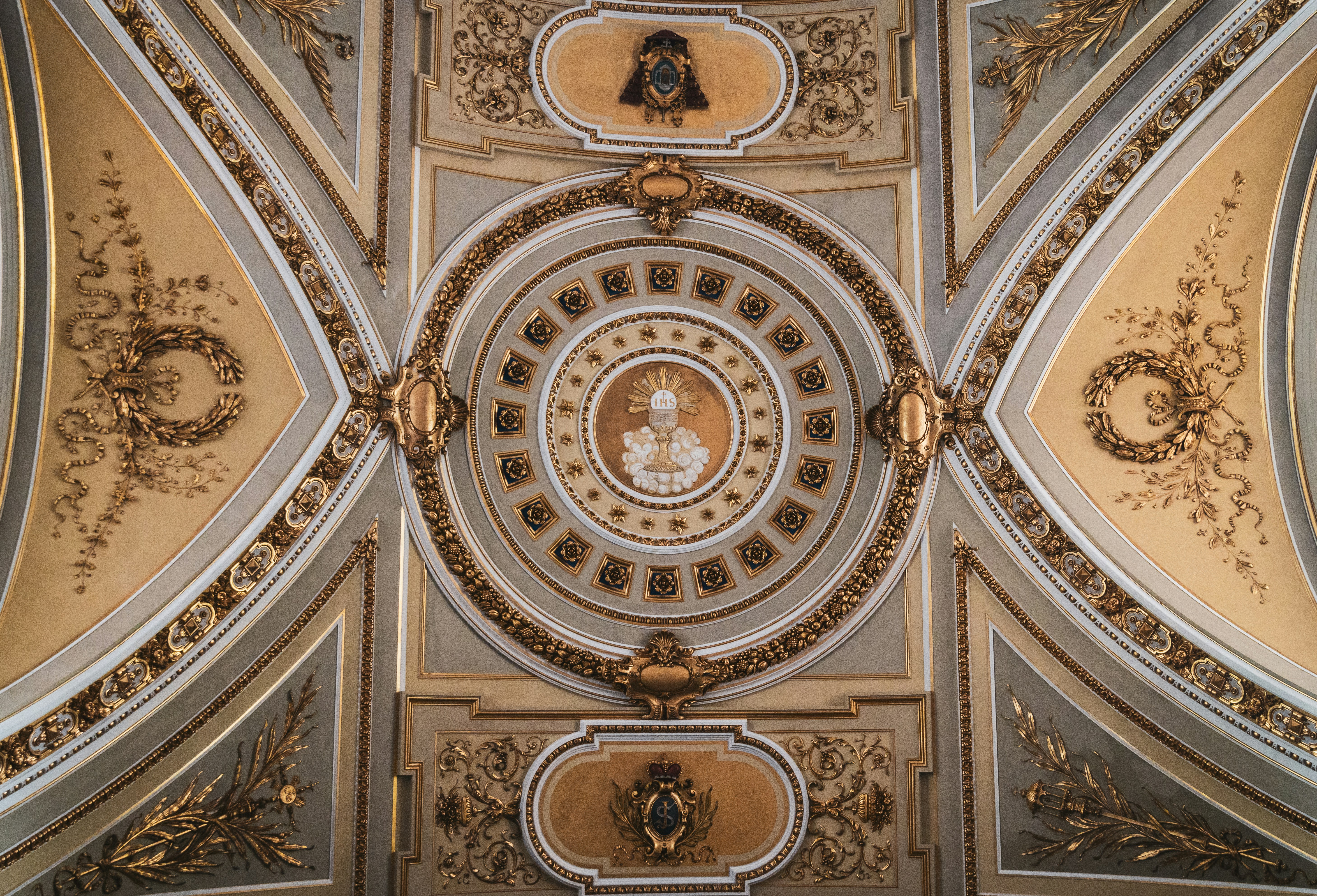 Ornate Dome within a Cathedral Ceiling: Symmetry and Gilded Embellishments