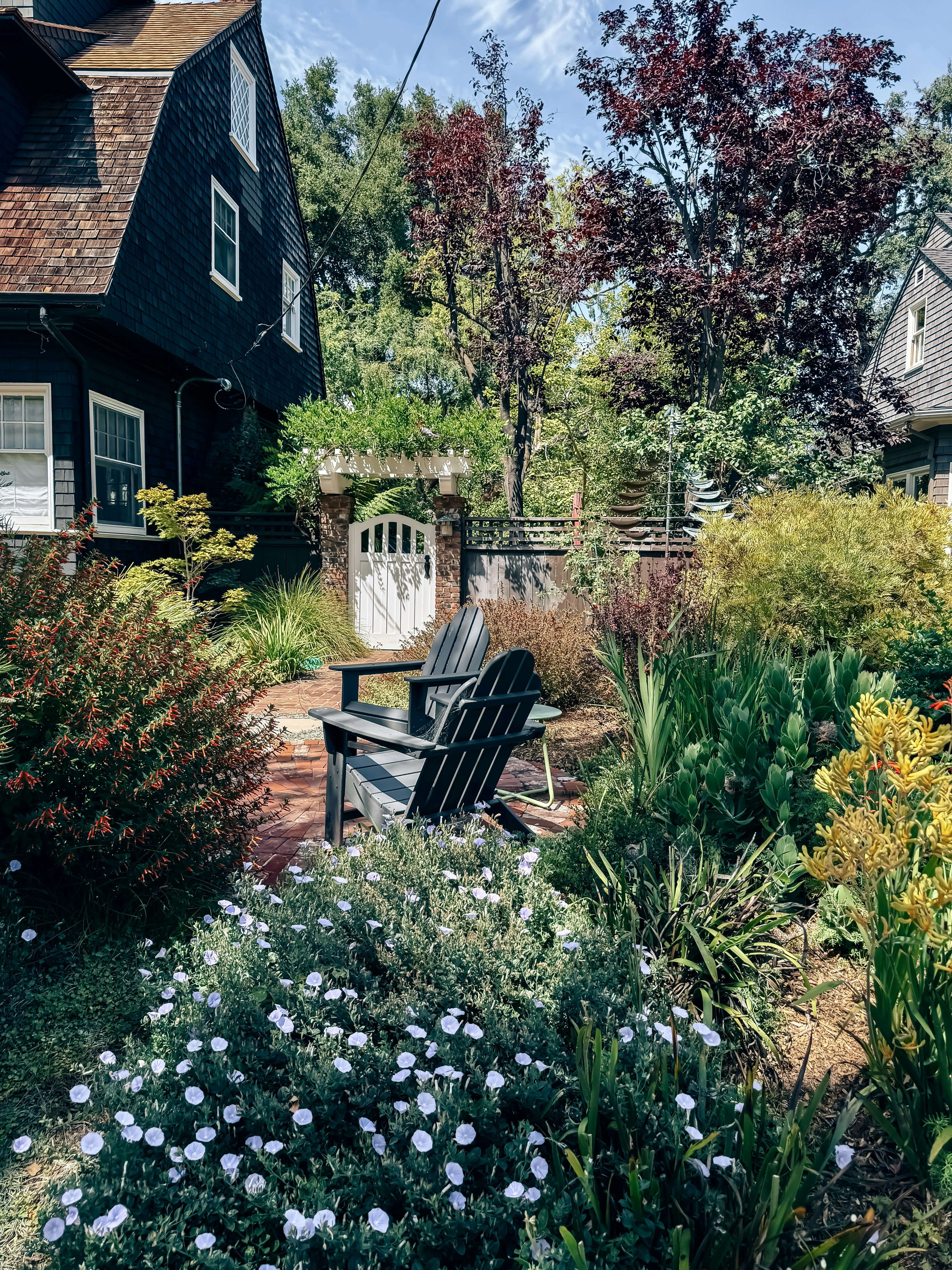 Tranquil Garden Terrace framed by cottage and lush blooms