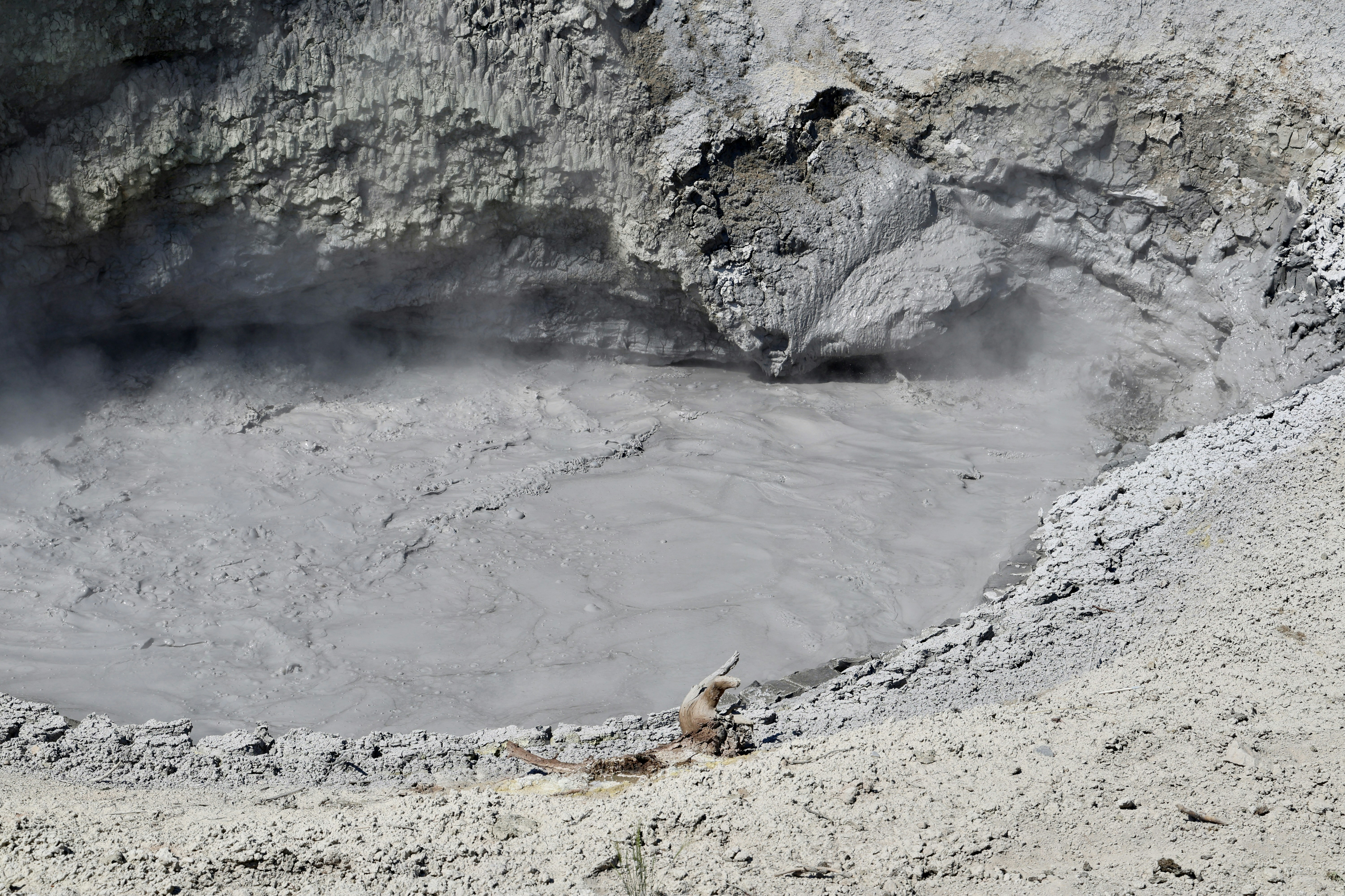Crater Edge Sentinel: A Crusty Figure Amid Silvery Steam