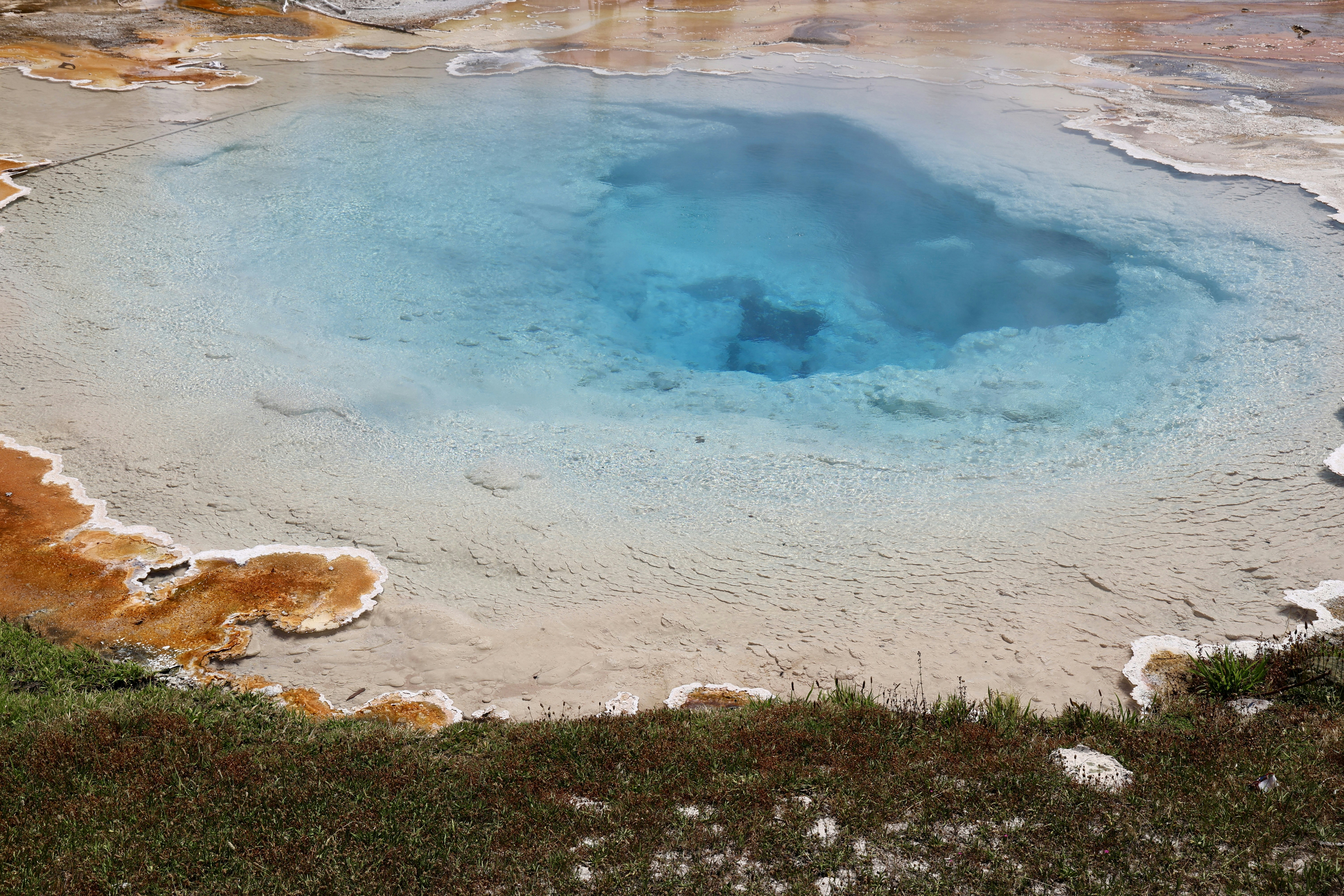 Azure Rim: A Crown of Mineral Pools Framing a Quiet Basin
