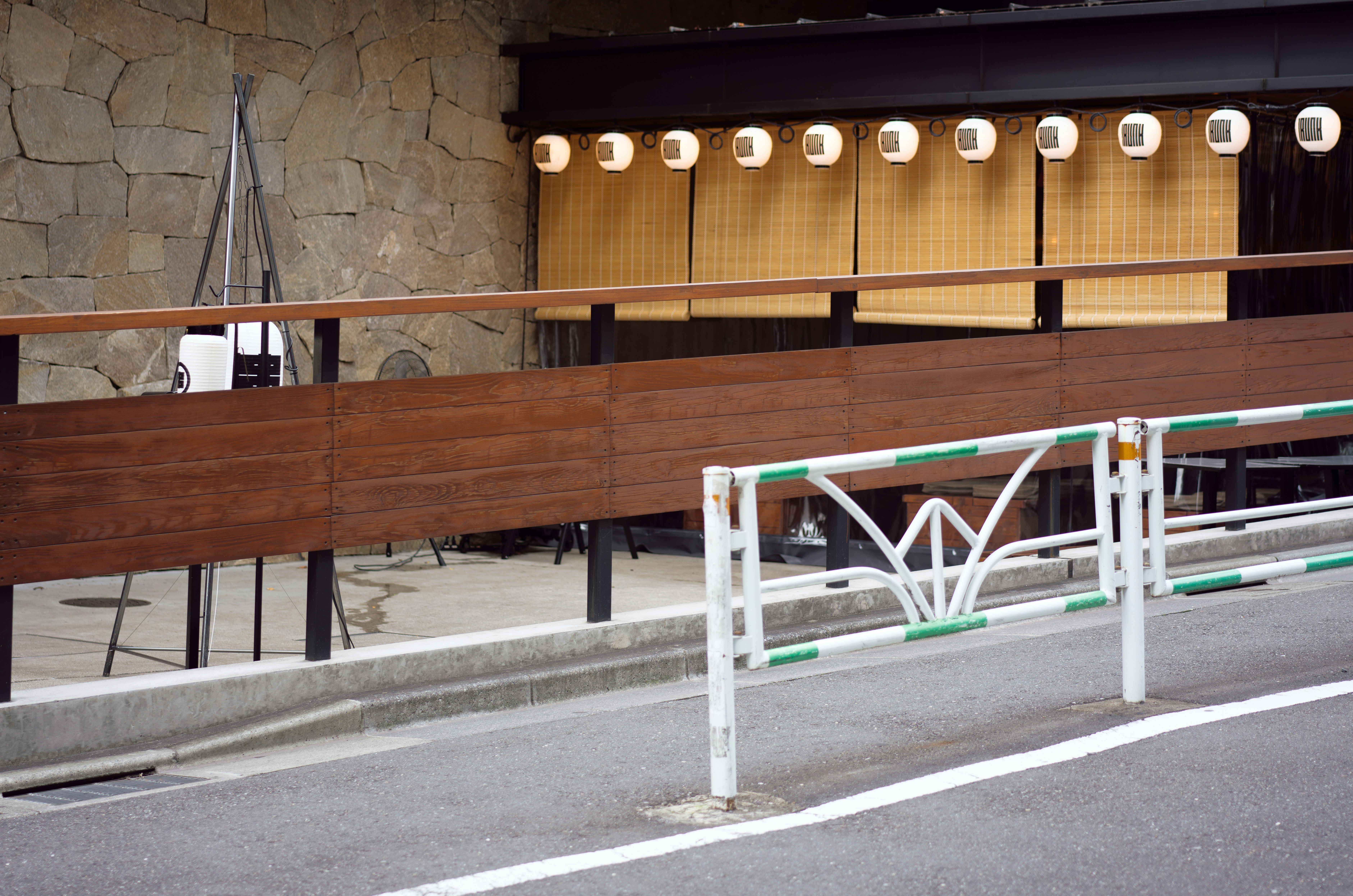 Street Theater: Lanterns, Railing, and Quiet Facade