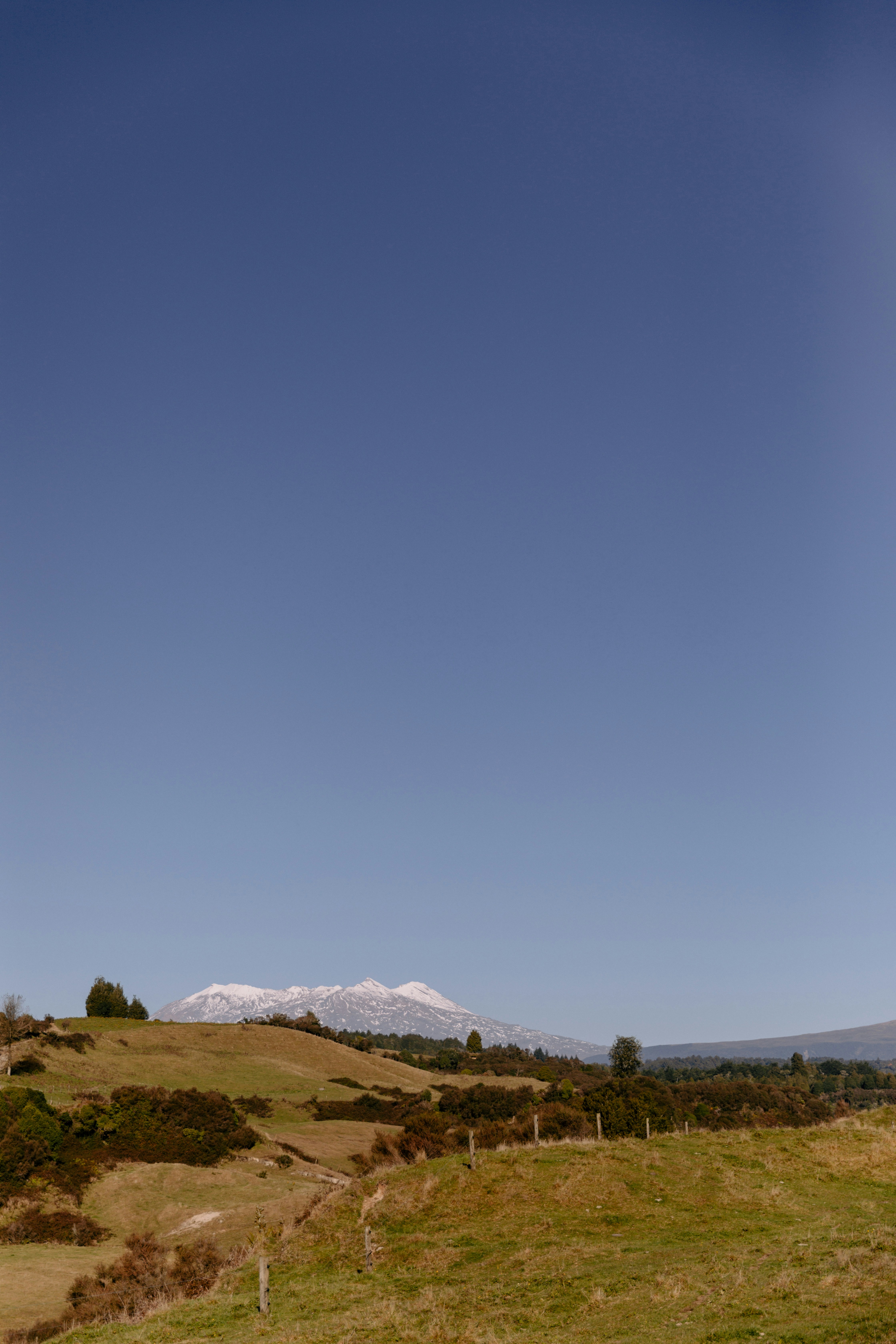 Snow-capped horizon beneath a vast blue dome
