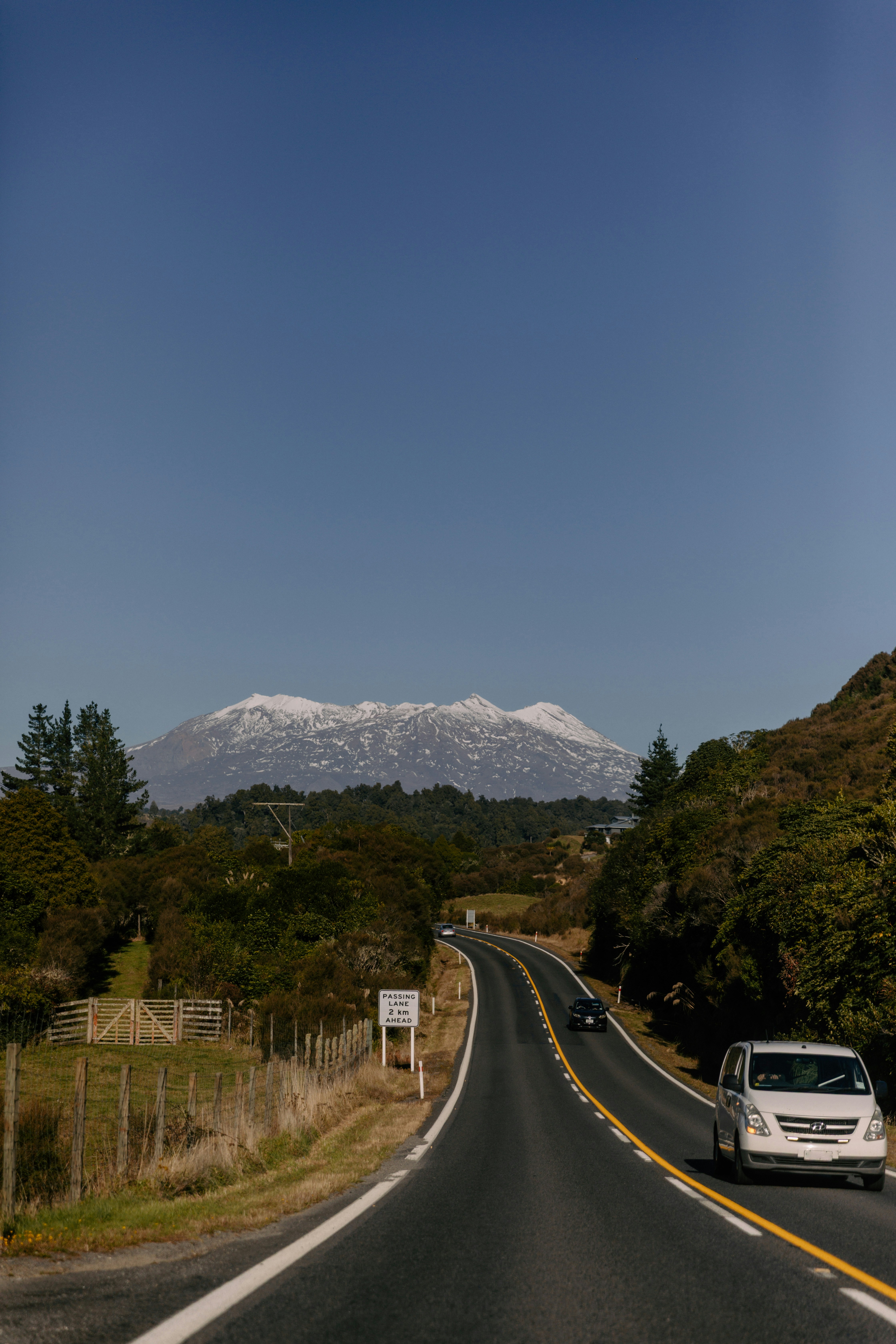 Snow-Capped Peaks Beyond a Quiet Rural Highway