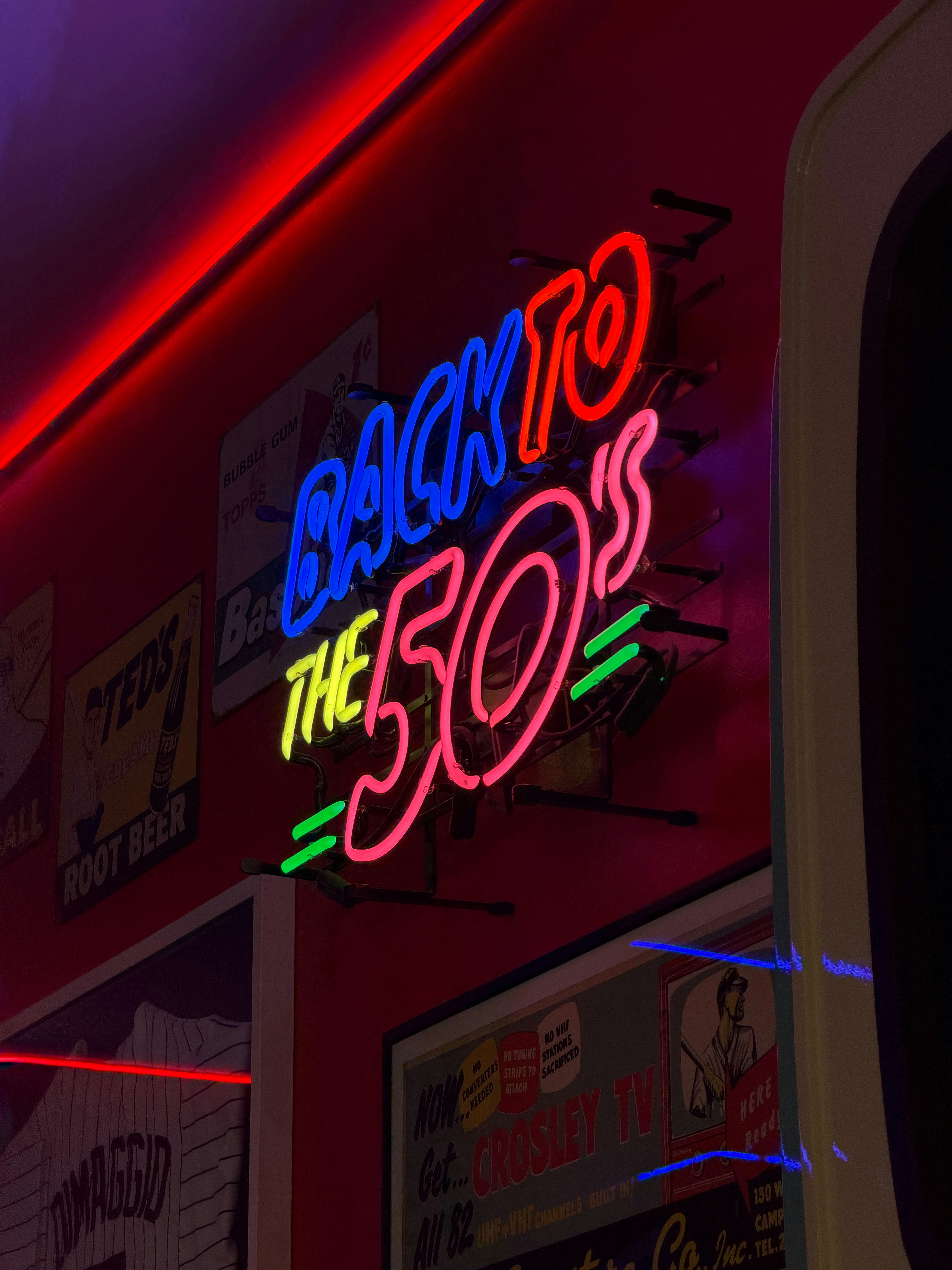 Neon cinema: Back to the 50s glow behind a red-lit storefront