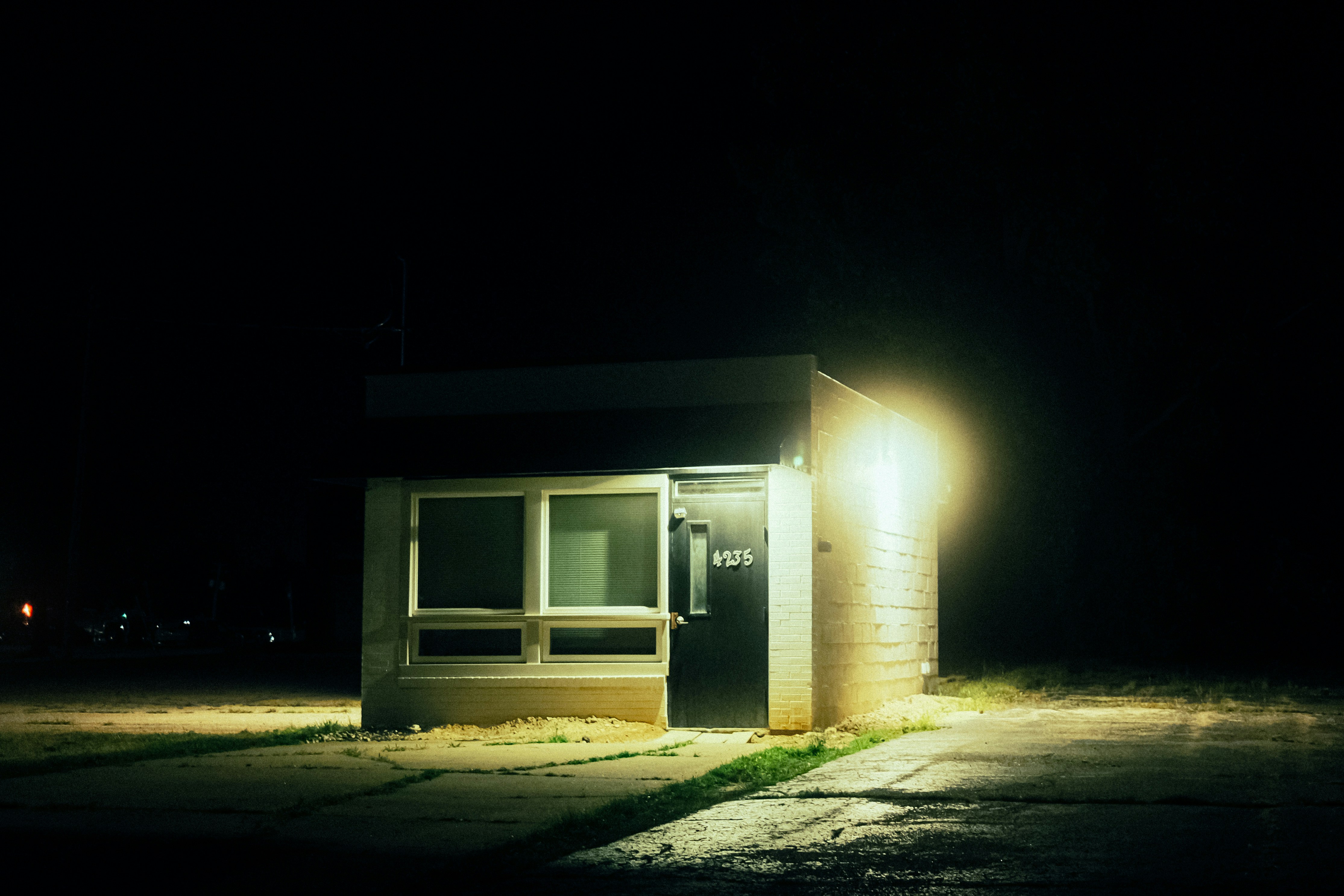 Lone Night Stop: An Abandoned Guardhouse Under Neon Glow