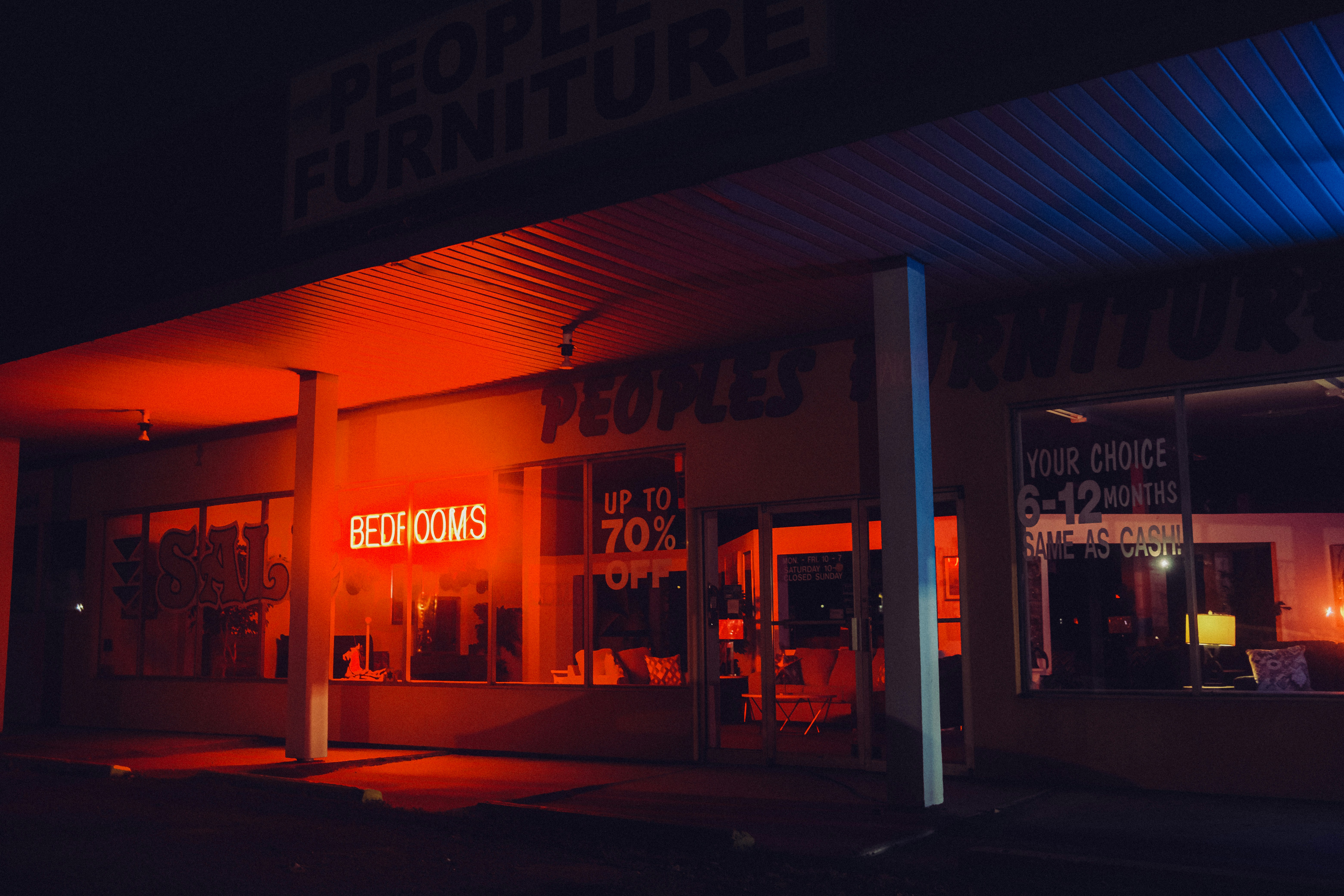 Neon Glow on a Closed Mall: Red Shopfronts in Night Shade