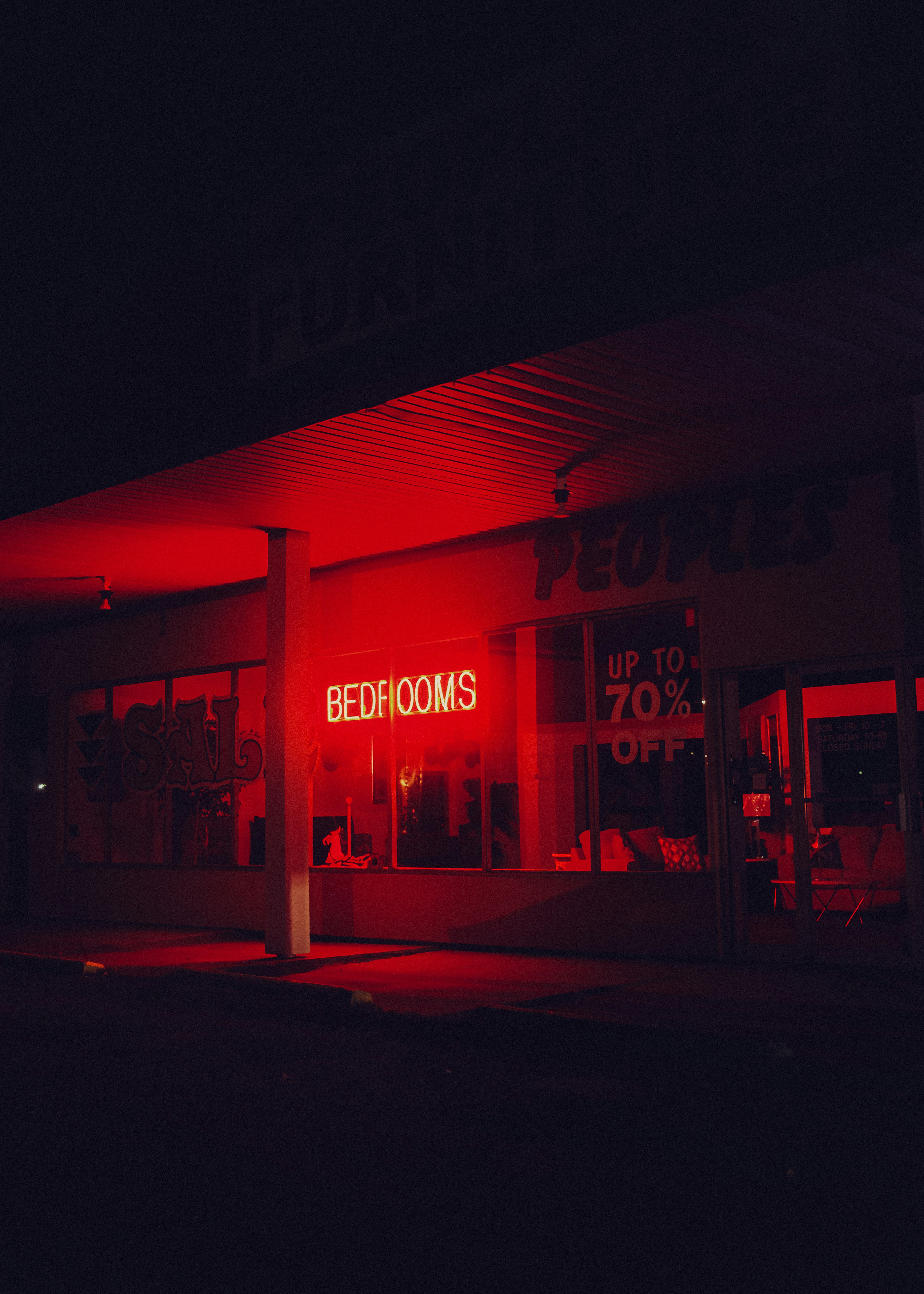 Neon Red Vacancy: Nighttime Retail Glow Behind a Closed Storefront