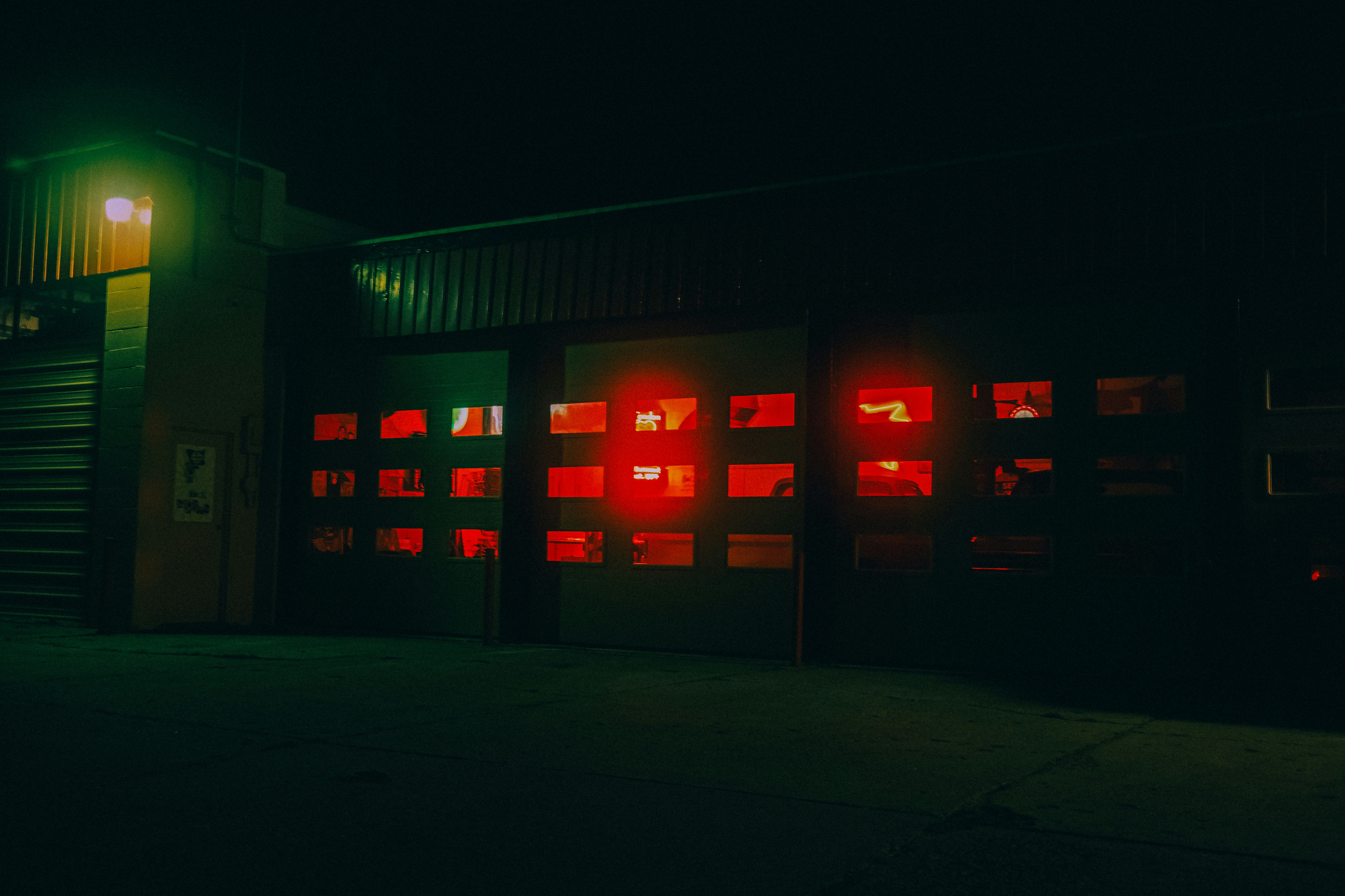 Neon Streaks Through a Closed Fire Garage at Night