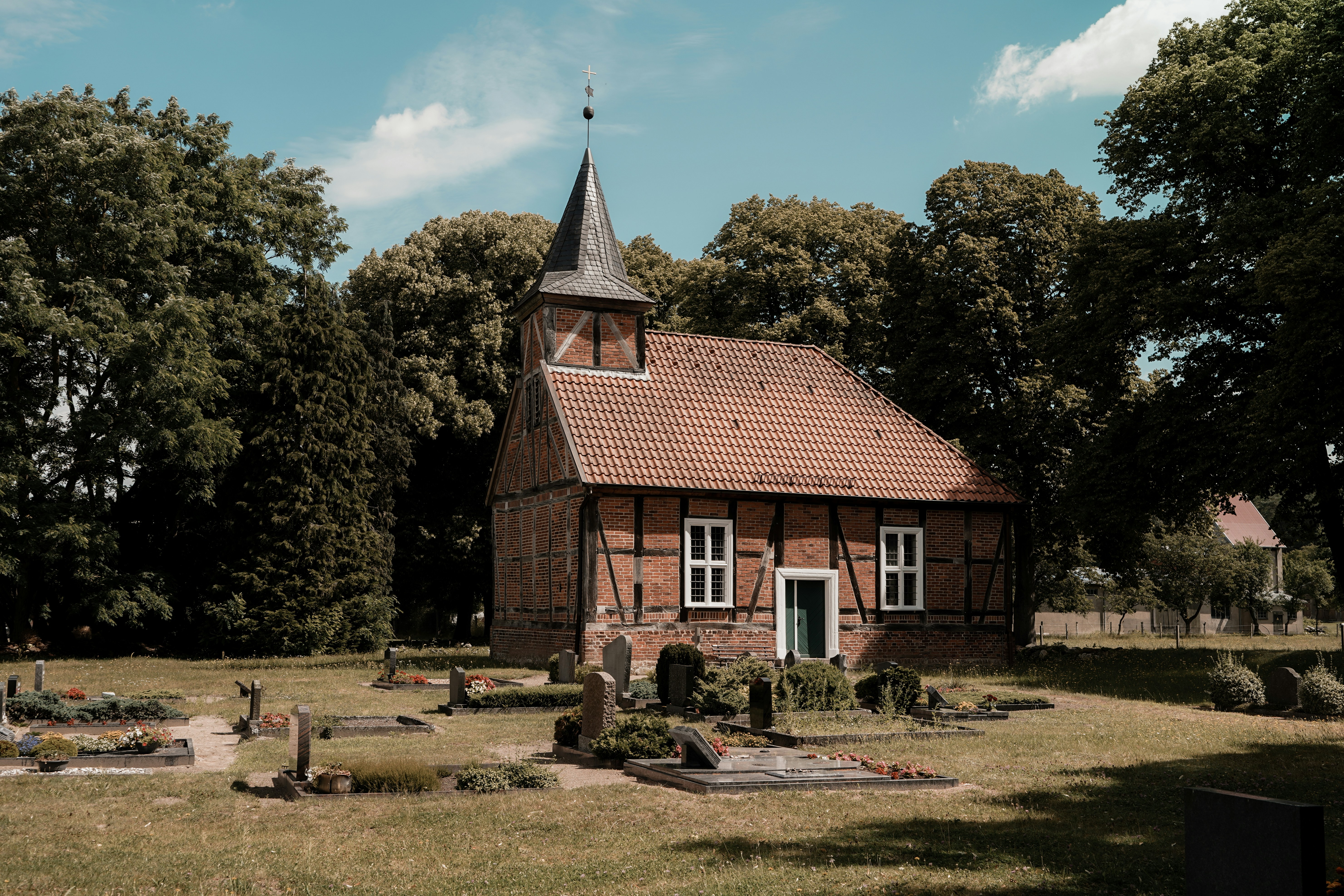 Sunlit Brick Church in a Quiet Cemetery