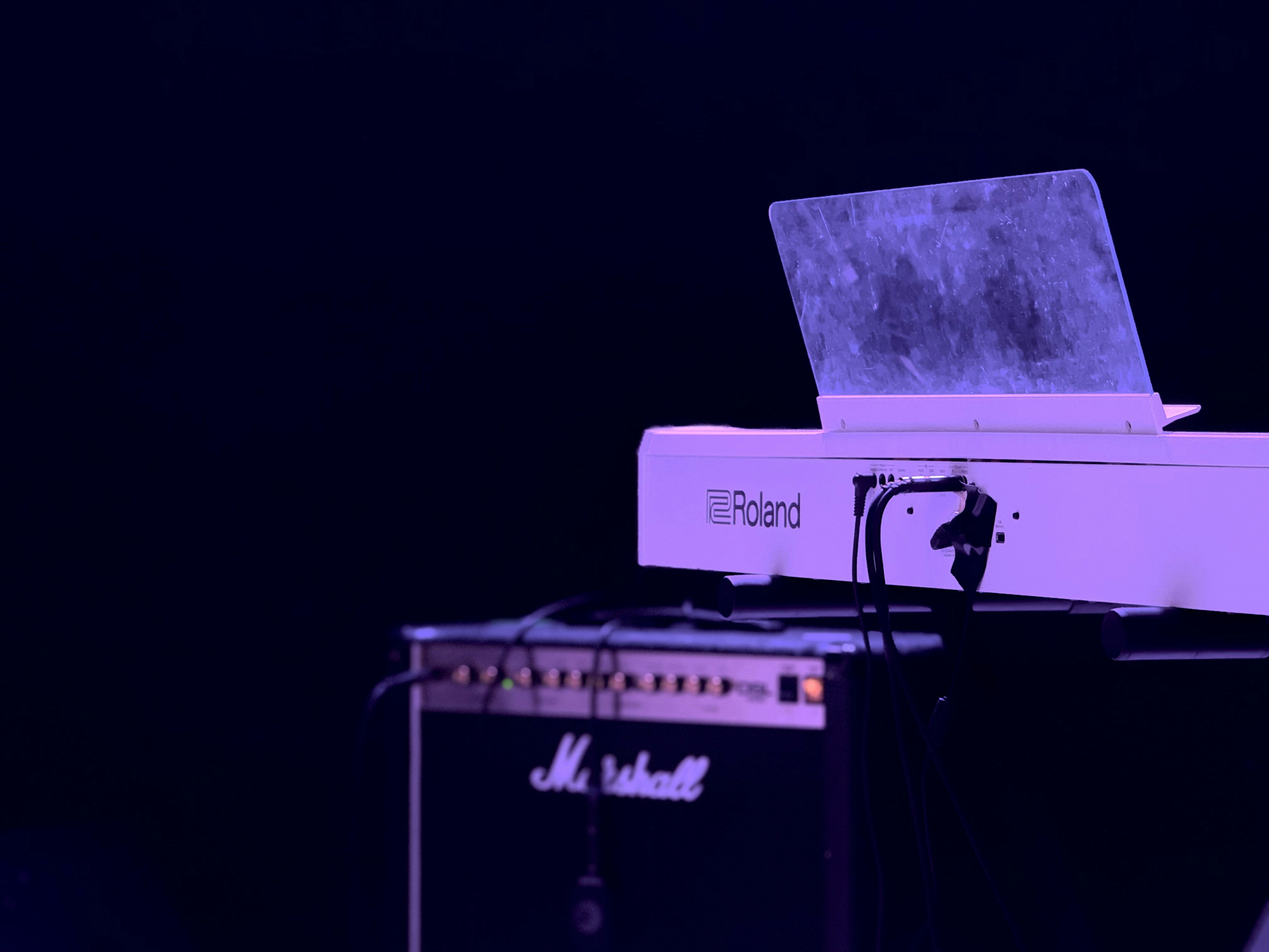 Neon-lit Synth Setup: Purple Hue on a Roland Keyboard