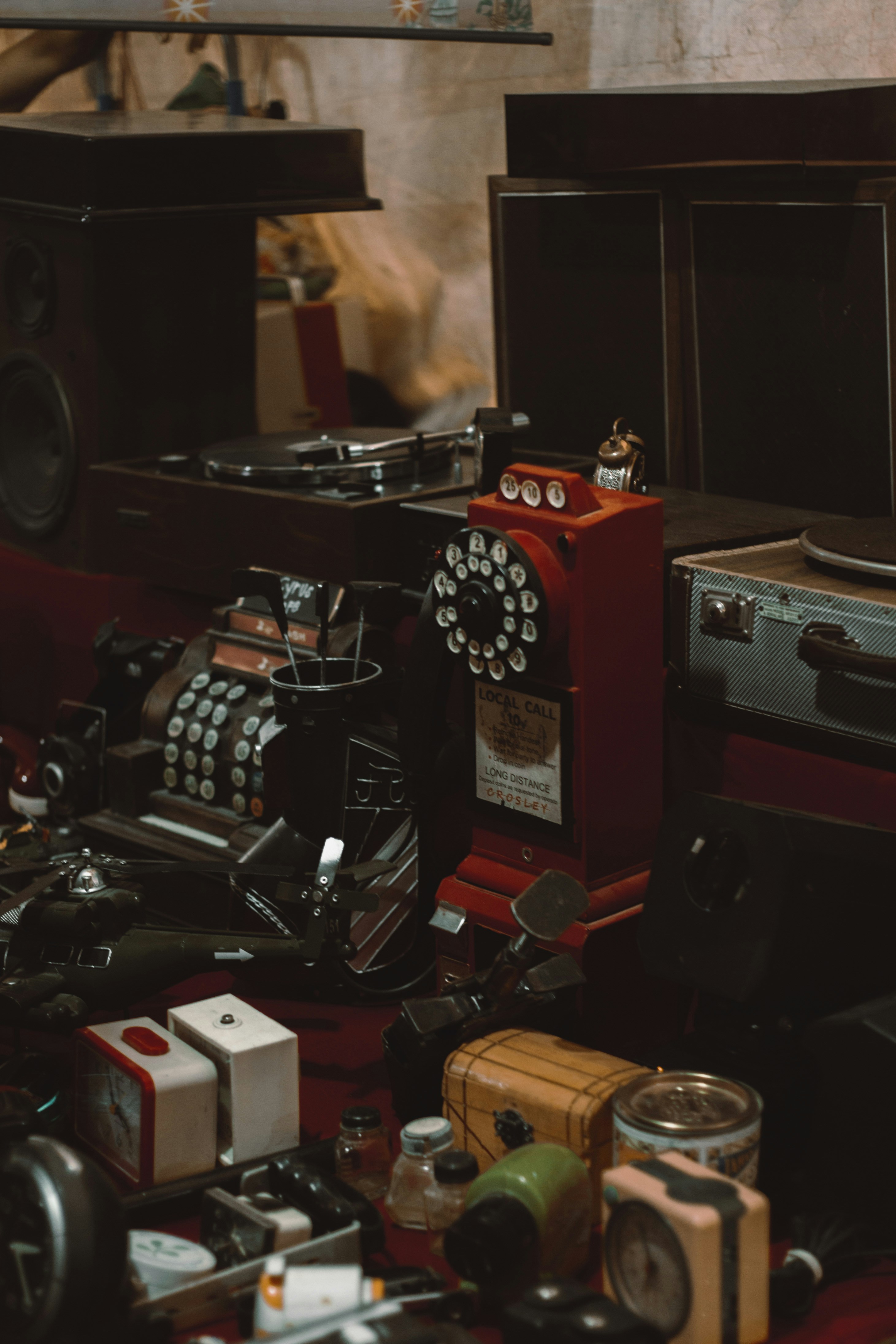 Vintage workspace: a brass telephone and antique tech anchor a cluttered studio scene