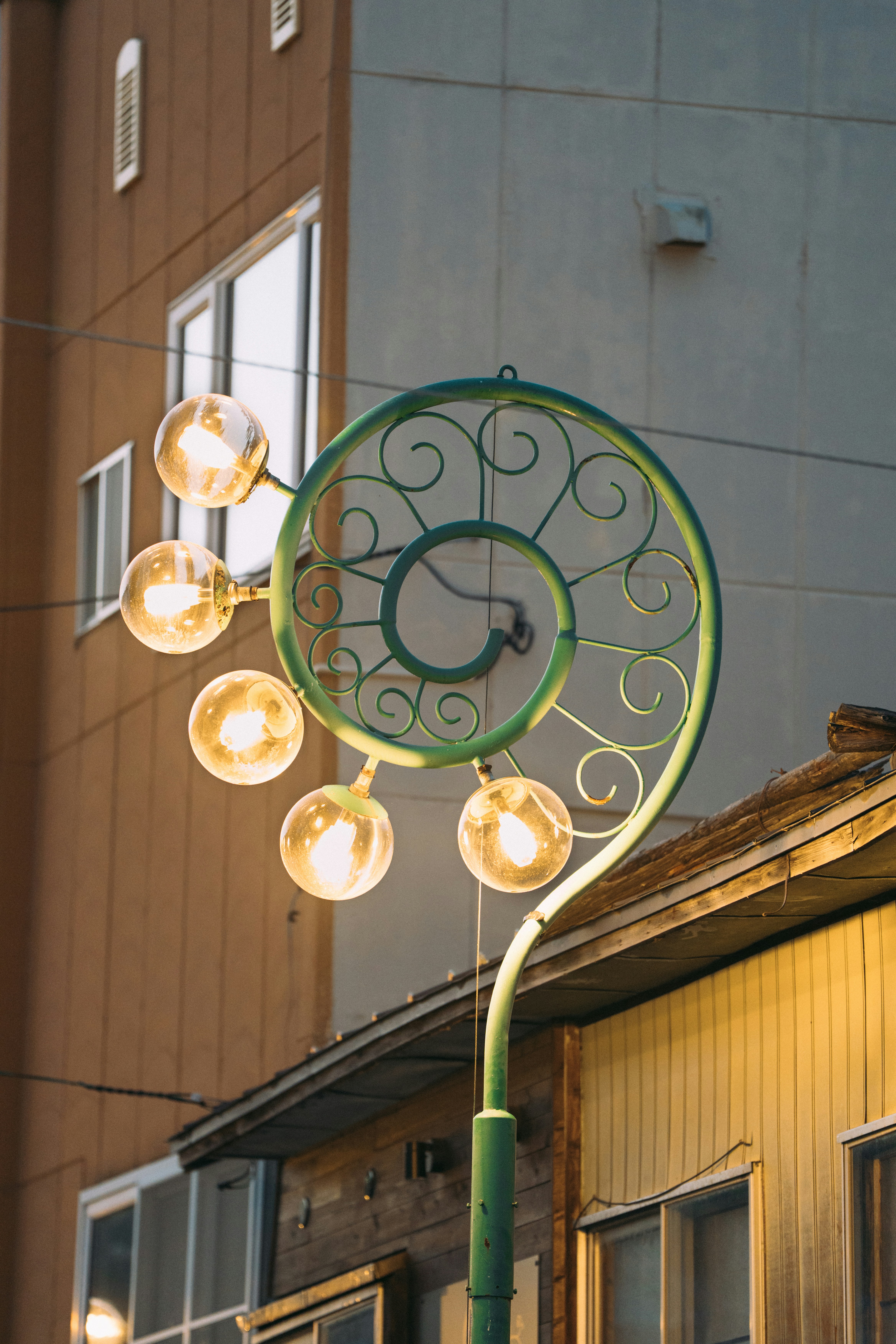 Spiral Glow: A Circular Streetlamp Illuminates the Alley