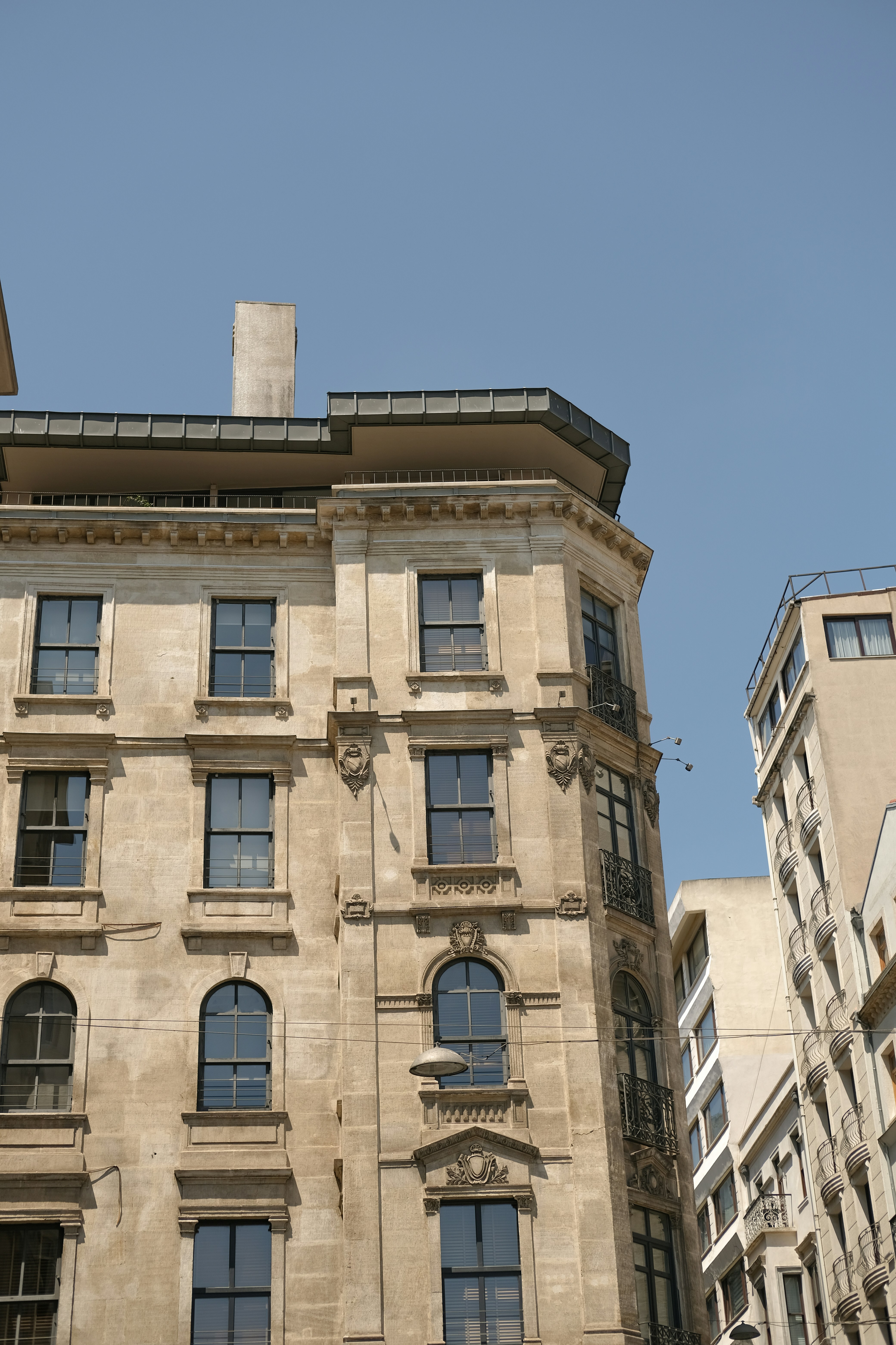 Cornerstone of a City: Sunlit Facade in Classical Stone