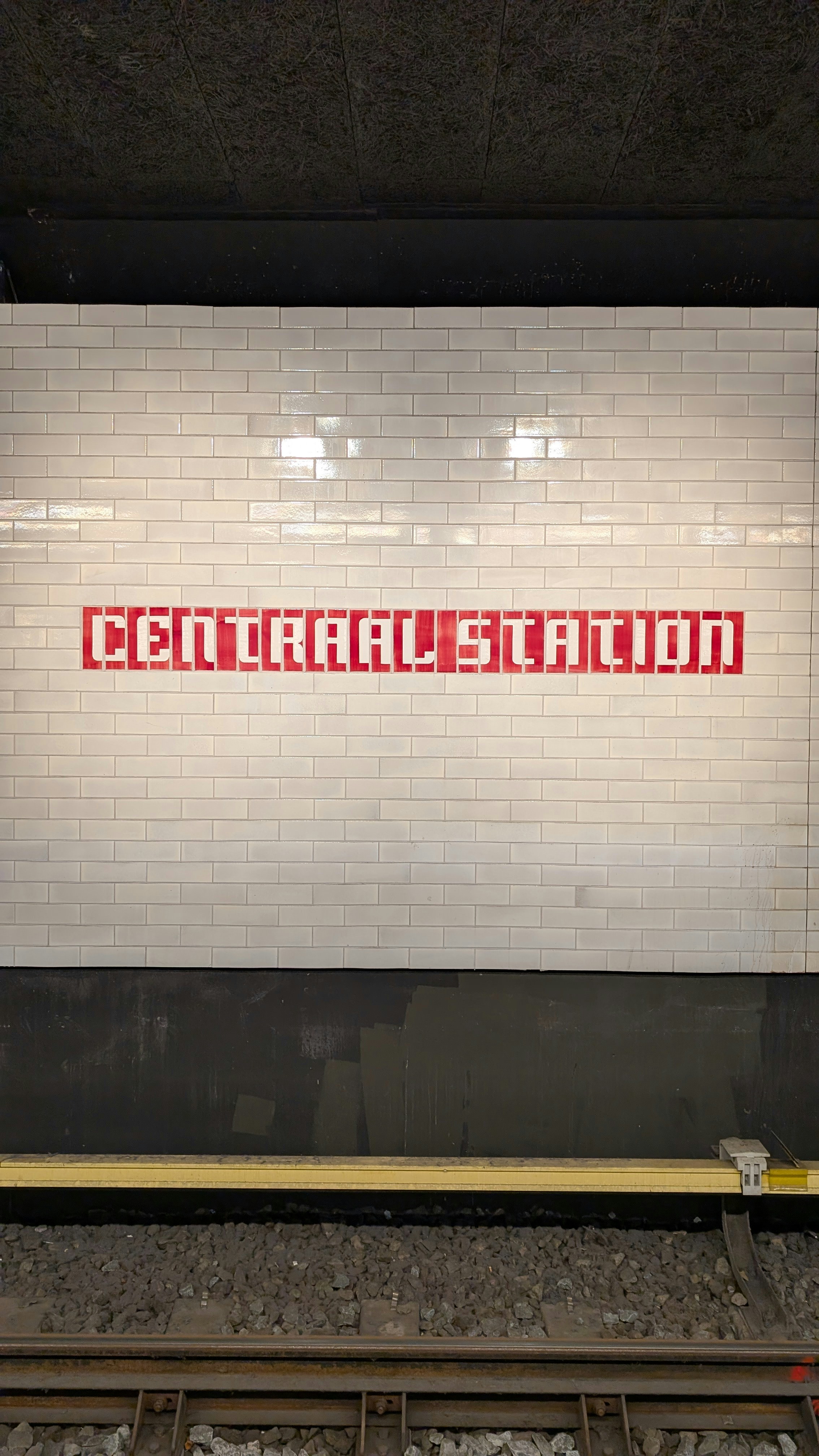 Subway Wall Whisper: Central Station in Red Letters