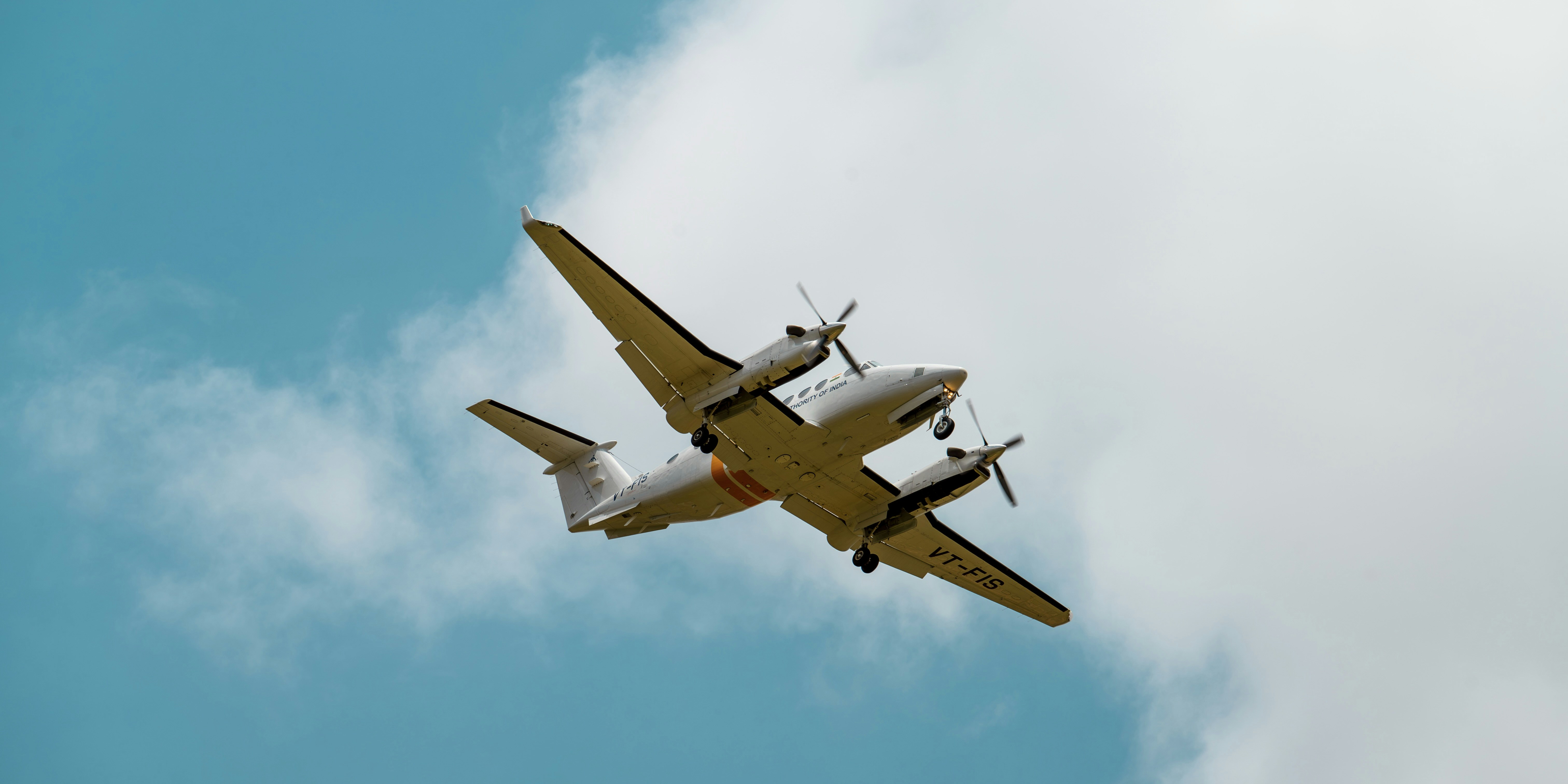 Twin-Prop Airplane Tracing a Skyward Arc