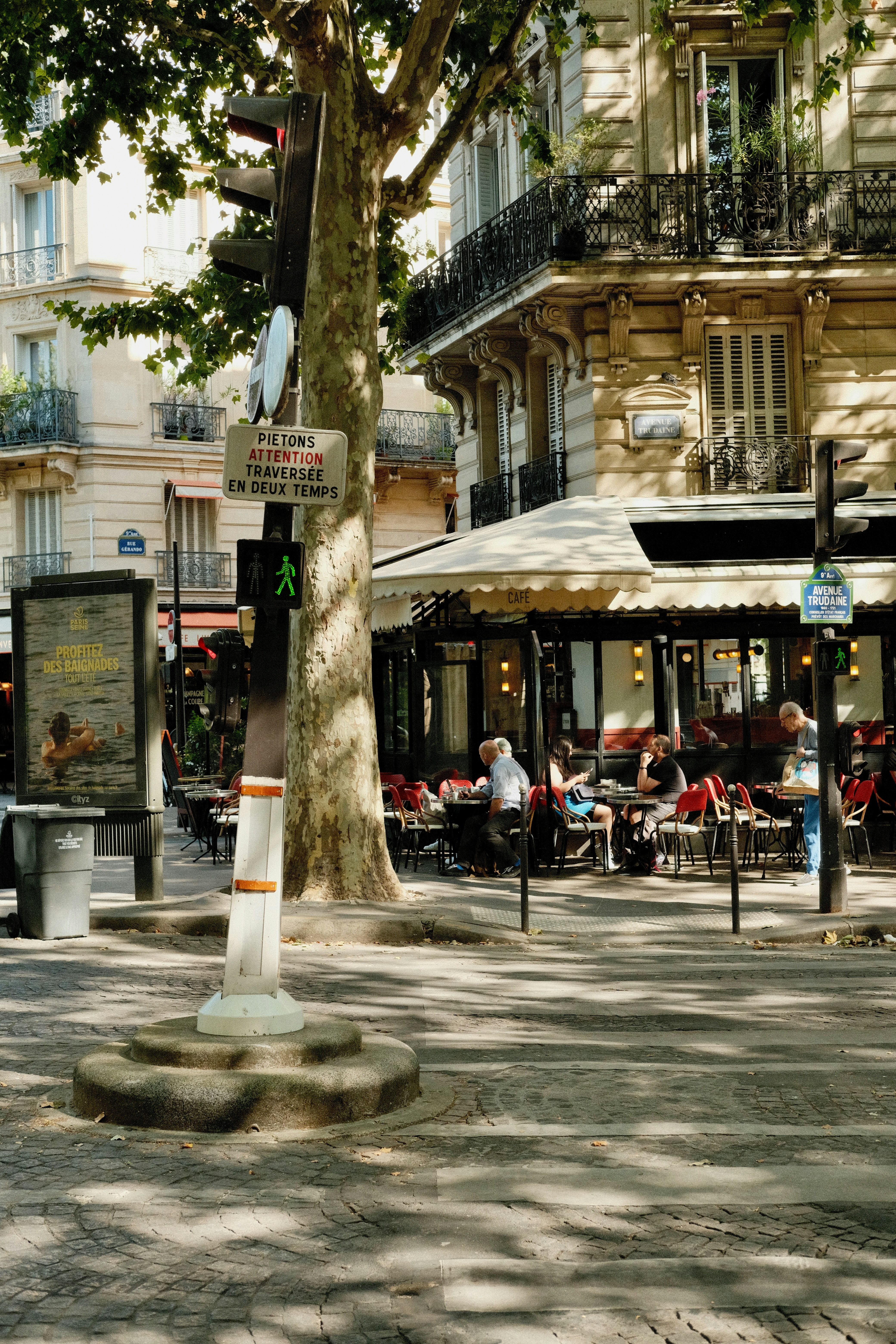 Parisian Café Corner: Dappled Light, Quiet Pedestrian Moment