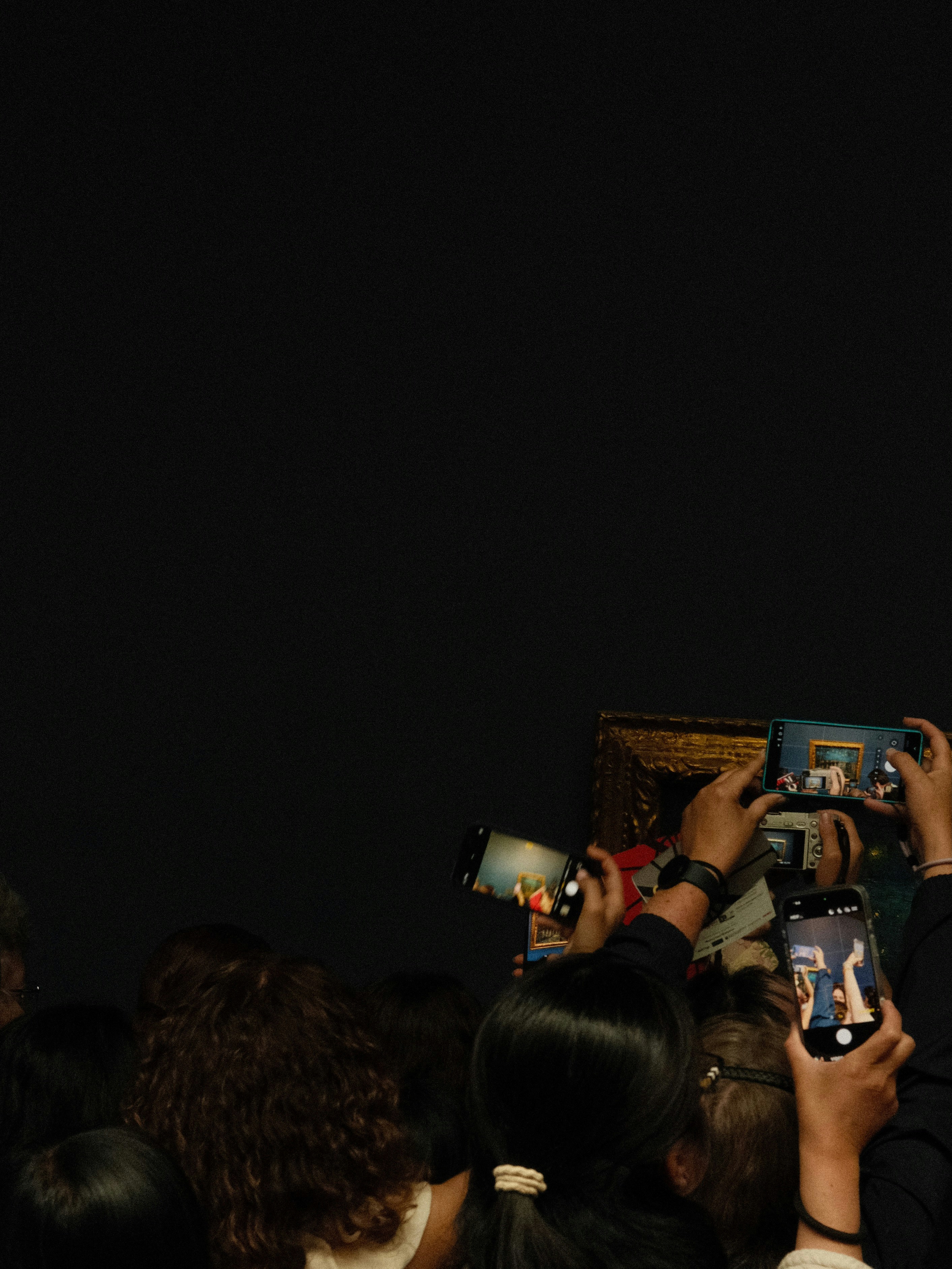 Crowded Nightscape: Fans Raise Phones Toward the Hidden Frame