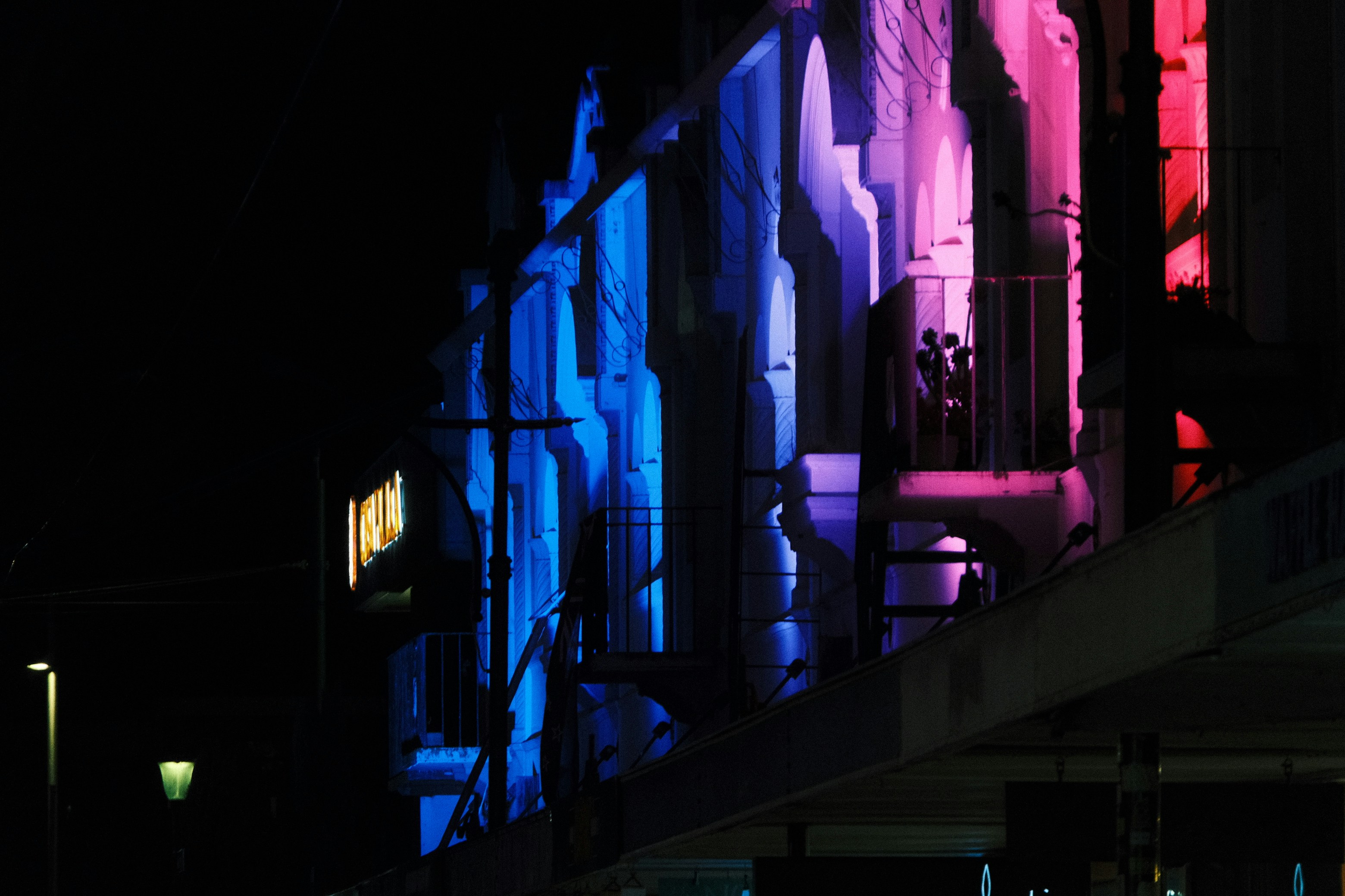Neon Facade: Night-time Color Cascade on a City Building