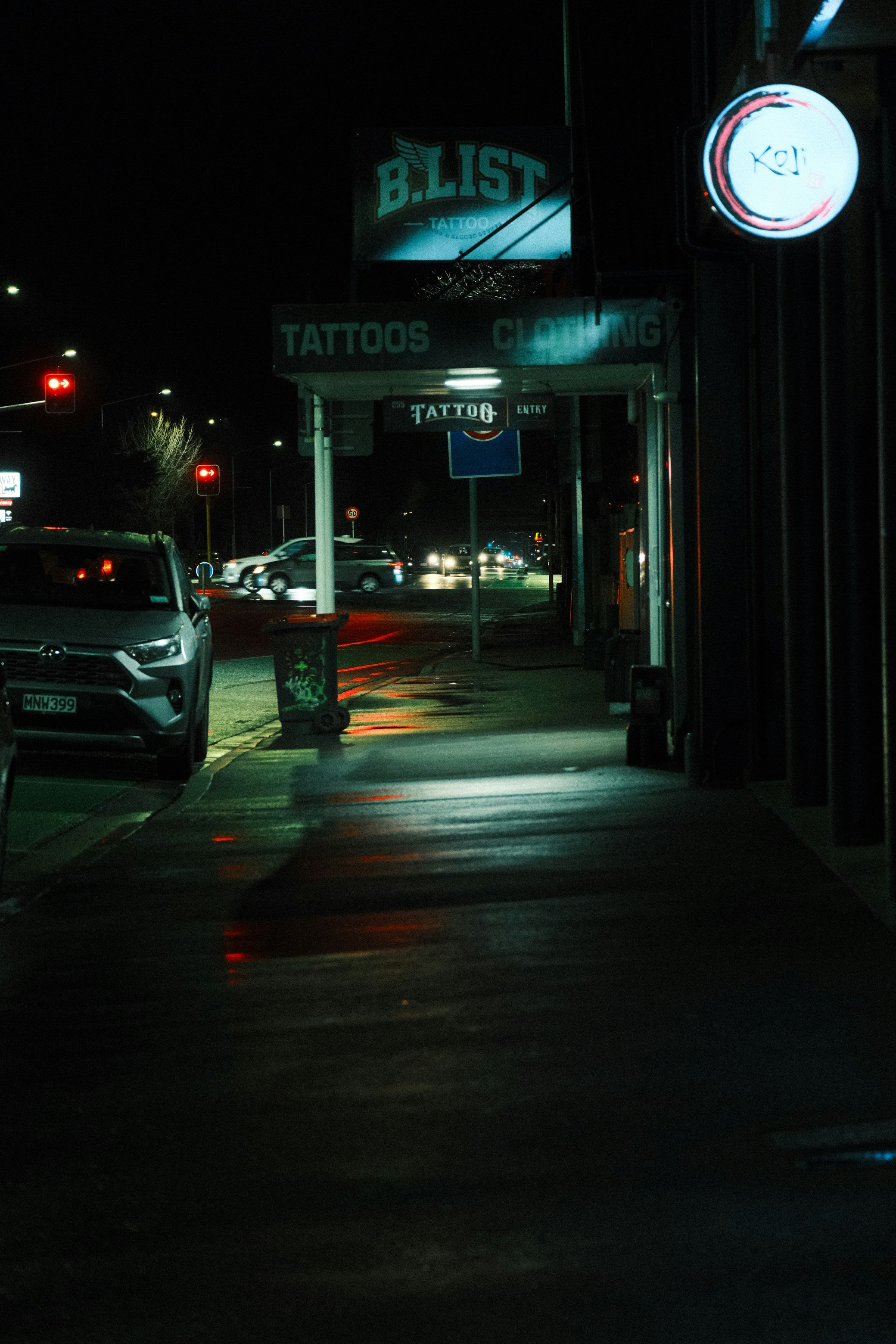 Night Neon and Tattoos: A Quiet Street Scene Illuminated by Neon Circles