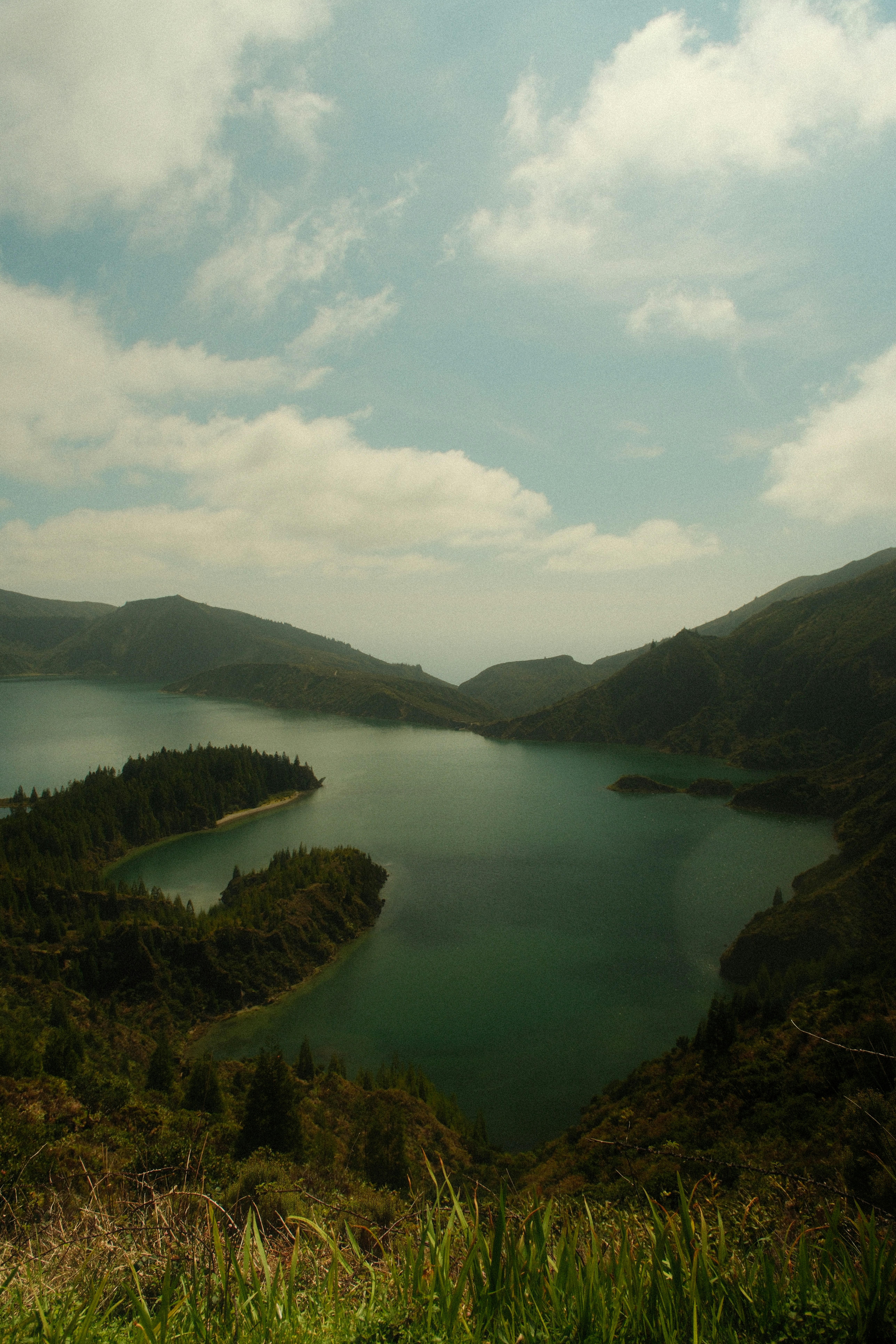 Serene Lake Bend: A Panoramic Valley Between Emerald Hills