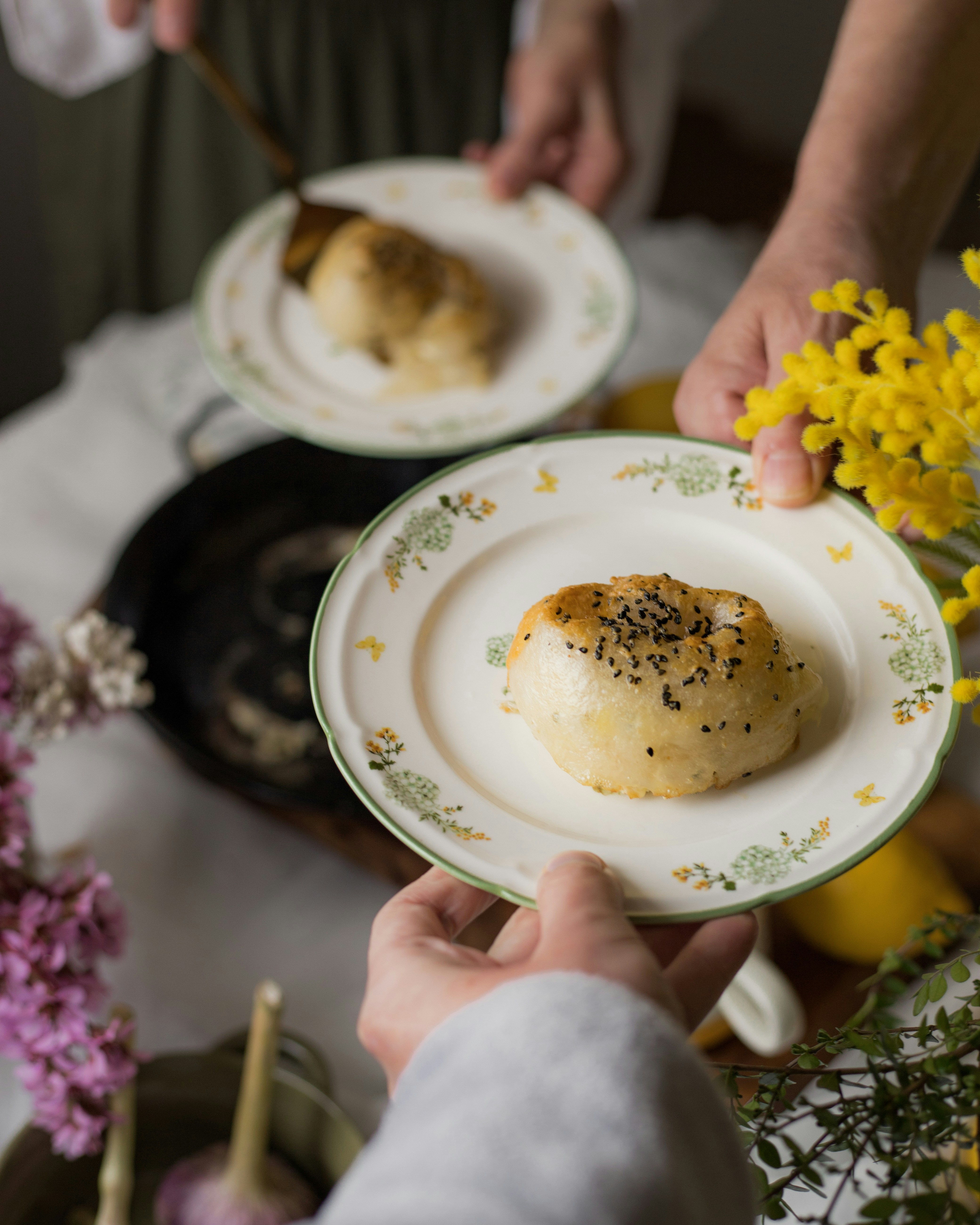 Soft Focus Pastry Moment: A Shared Bite at the Table