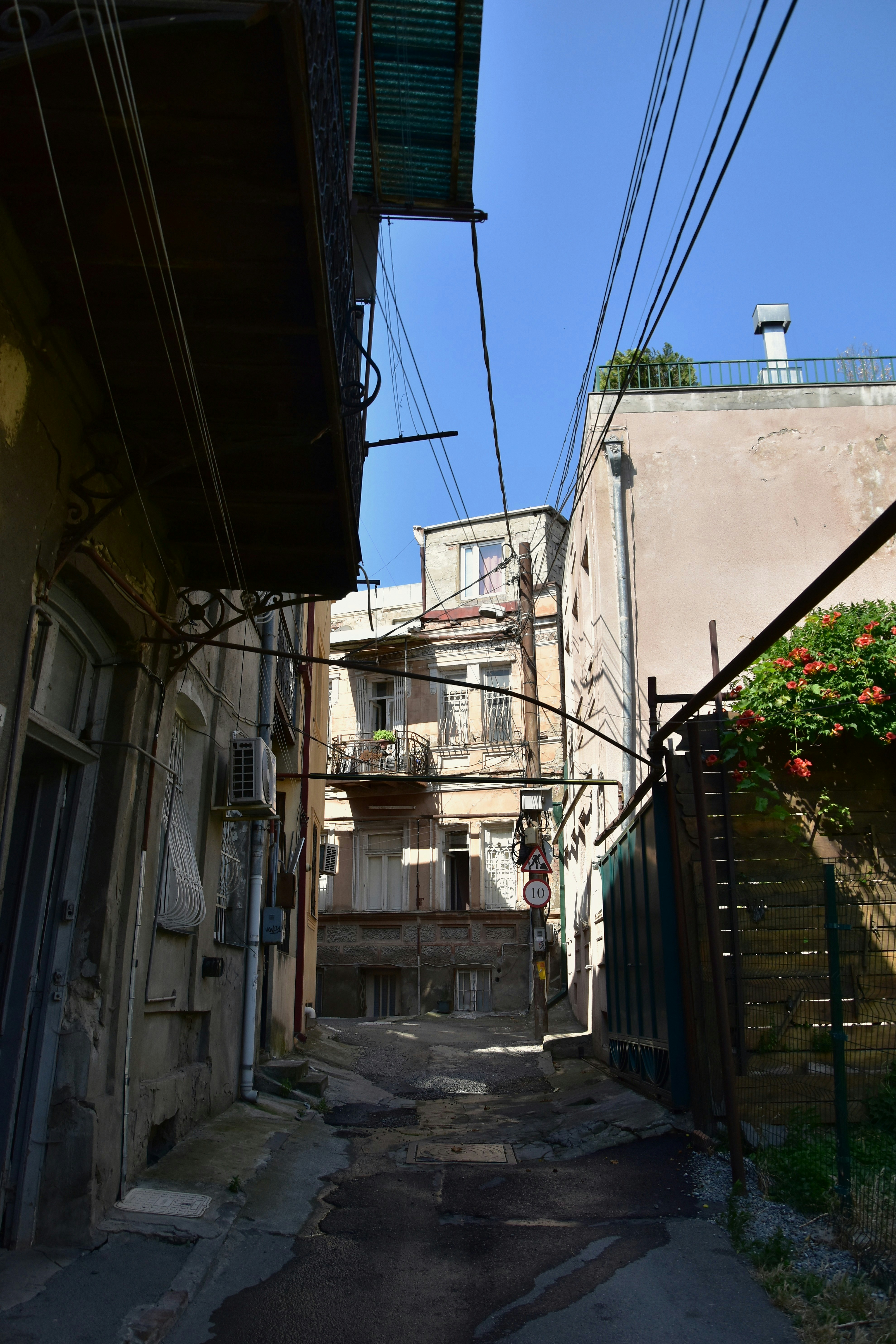Climb Through the Narrow Street: An Urban Alleyway Reaches Toward the Sky