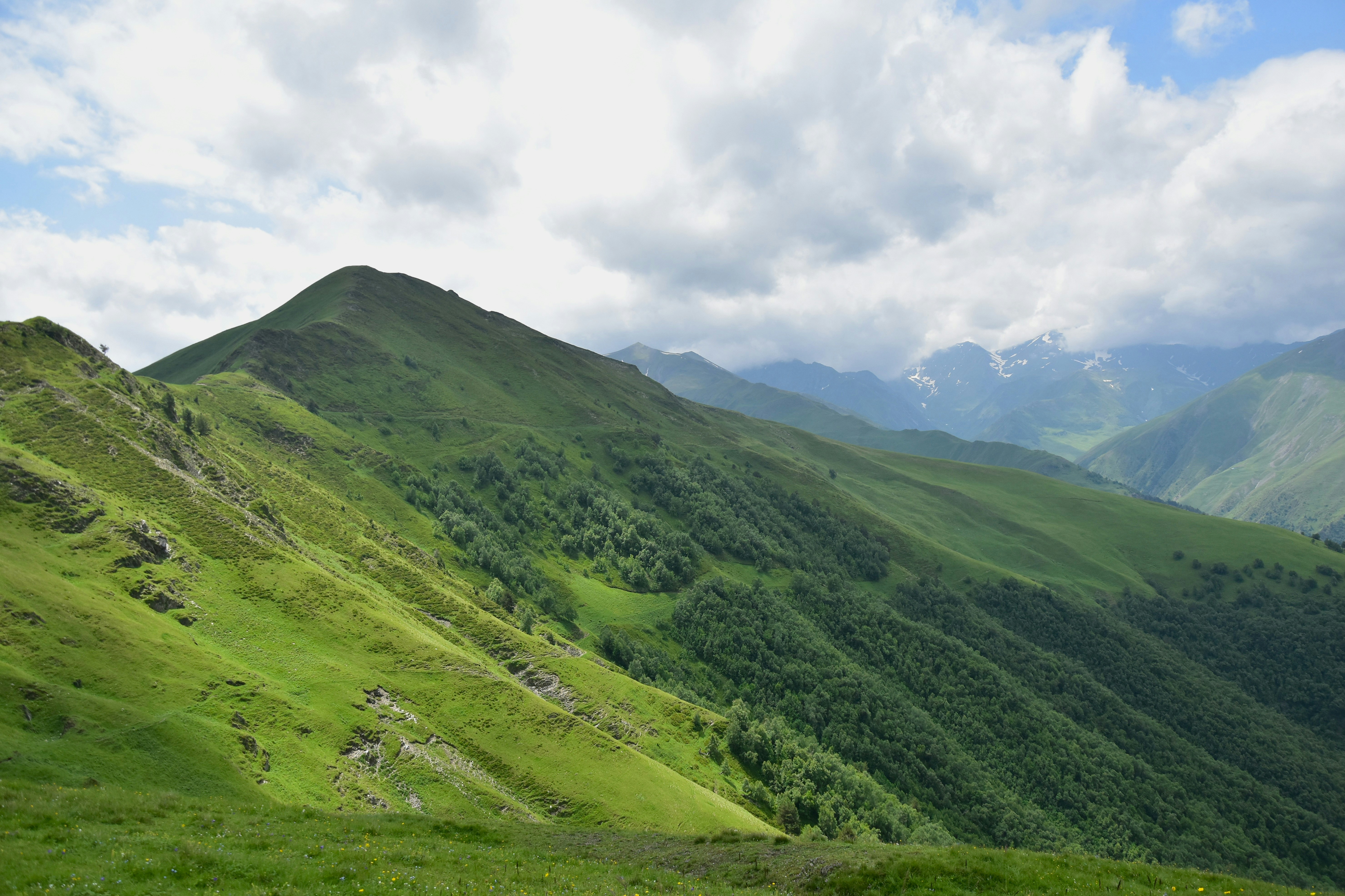 Green Ridge under a Cloudy Alpine Sky