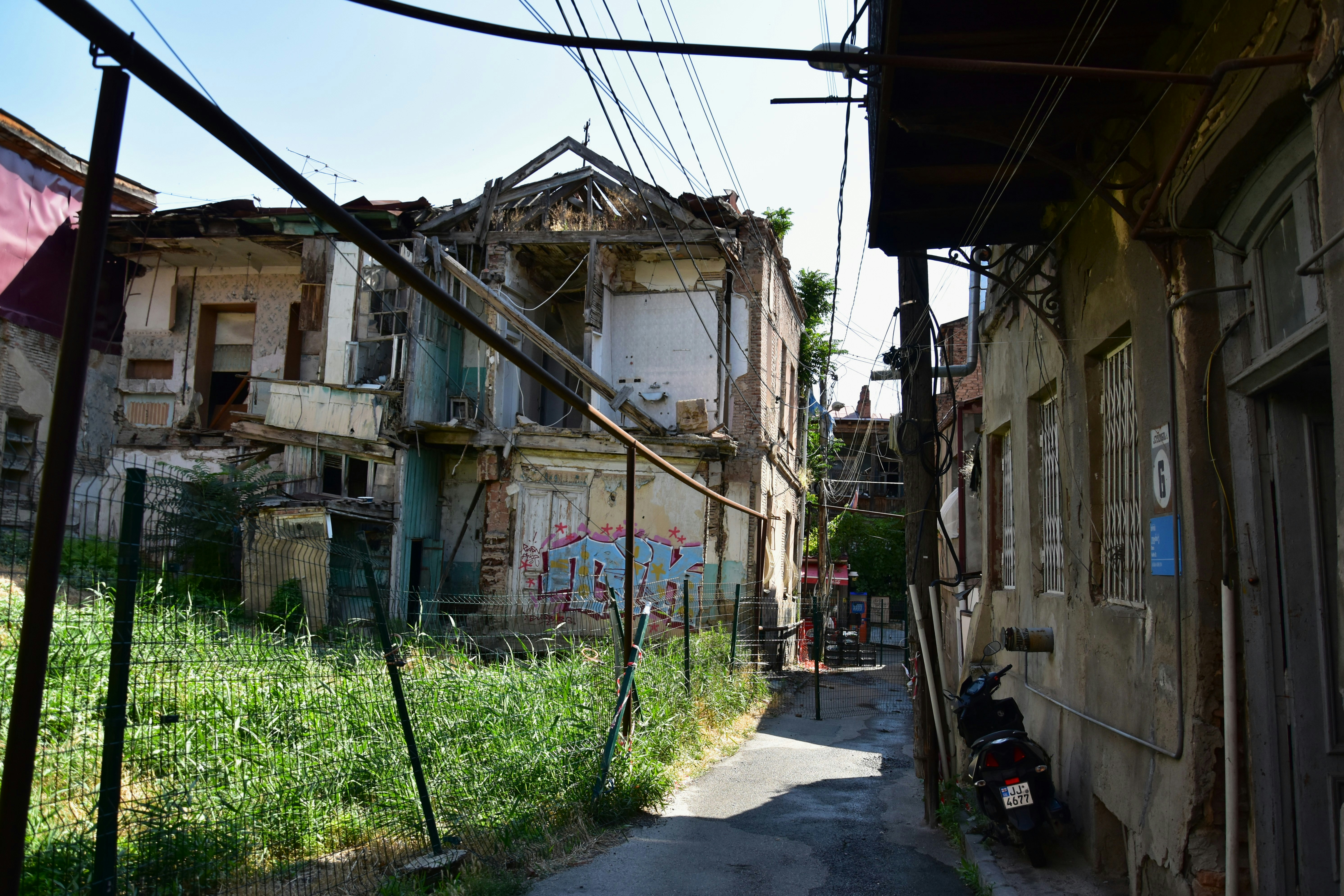 Grey Alley Between Echoing Walls and Wires