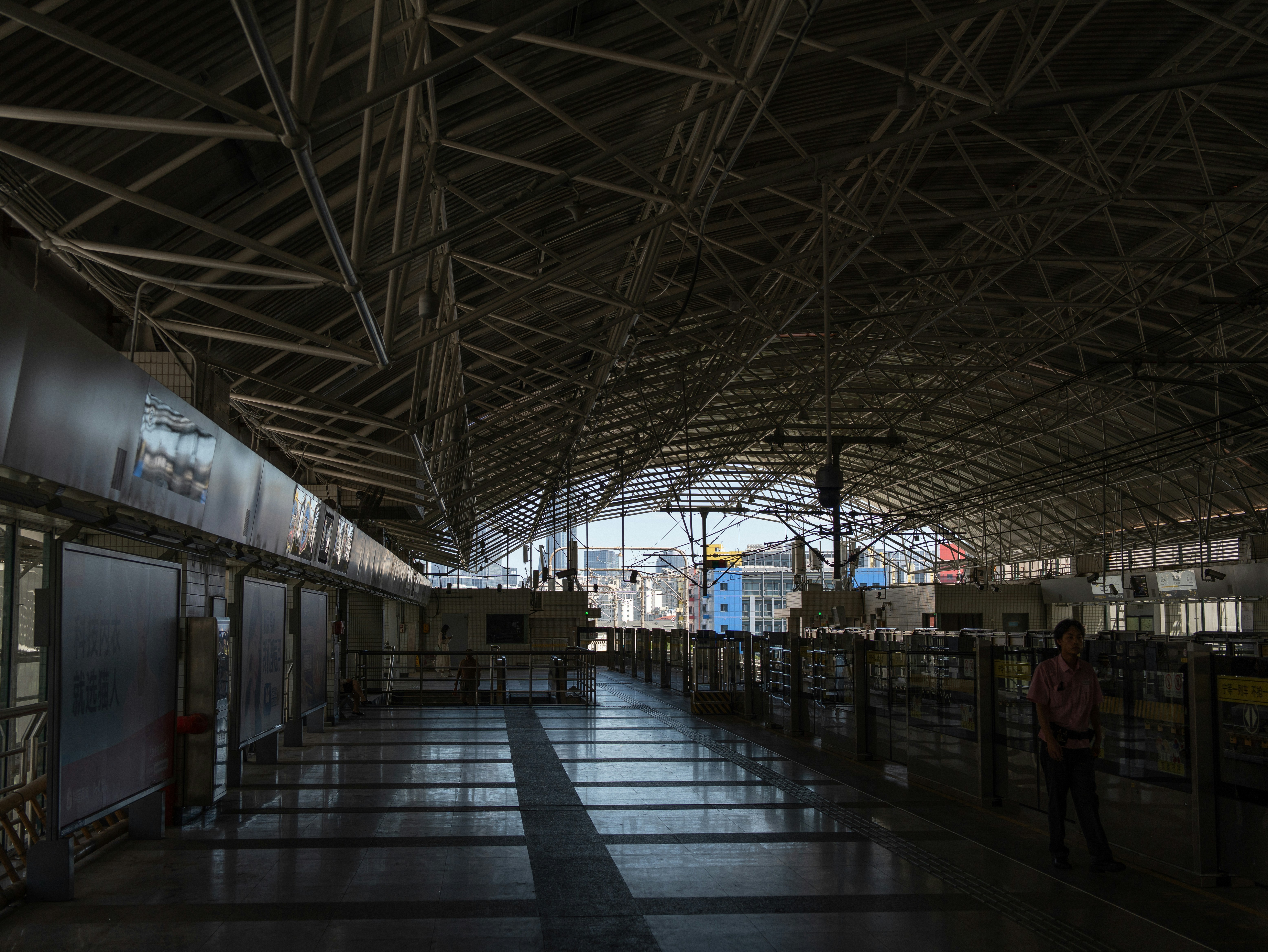 Sunlit Corridor Under Cathedral-like Steel Trusses