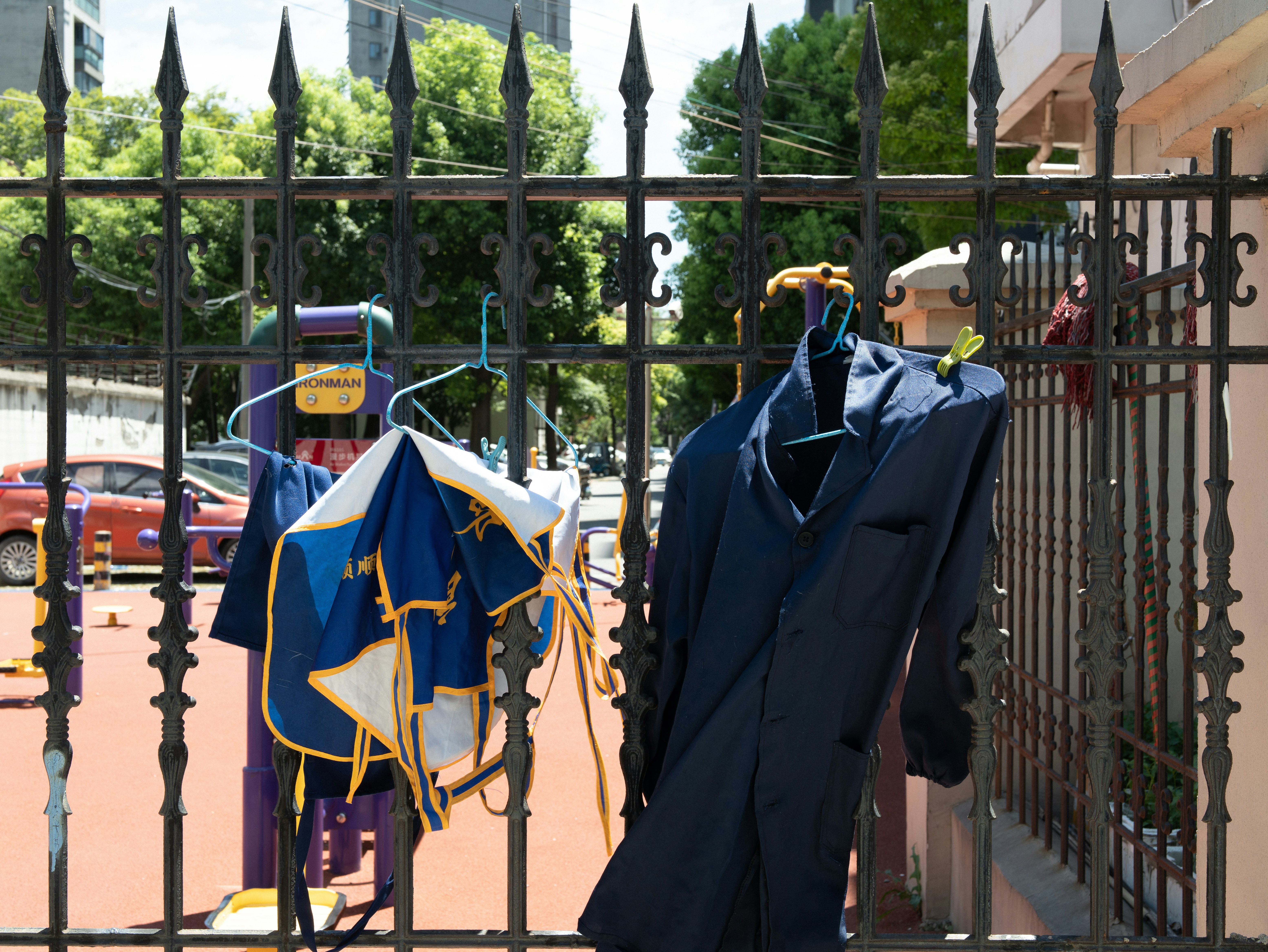 Blue and Navy Garments Guarding a Gate