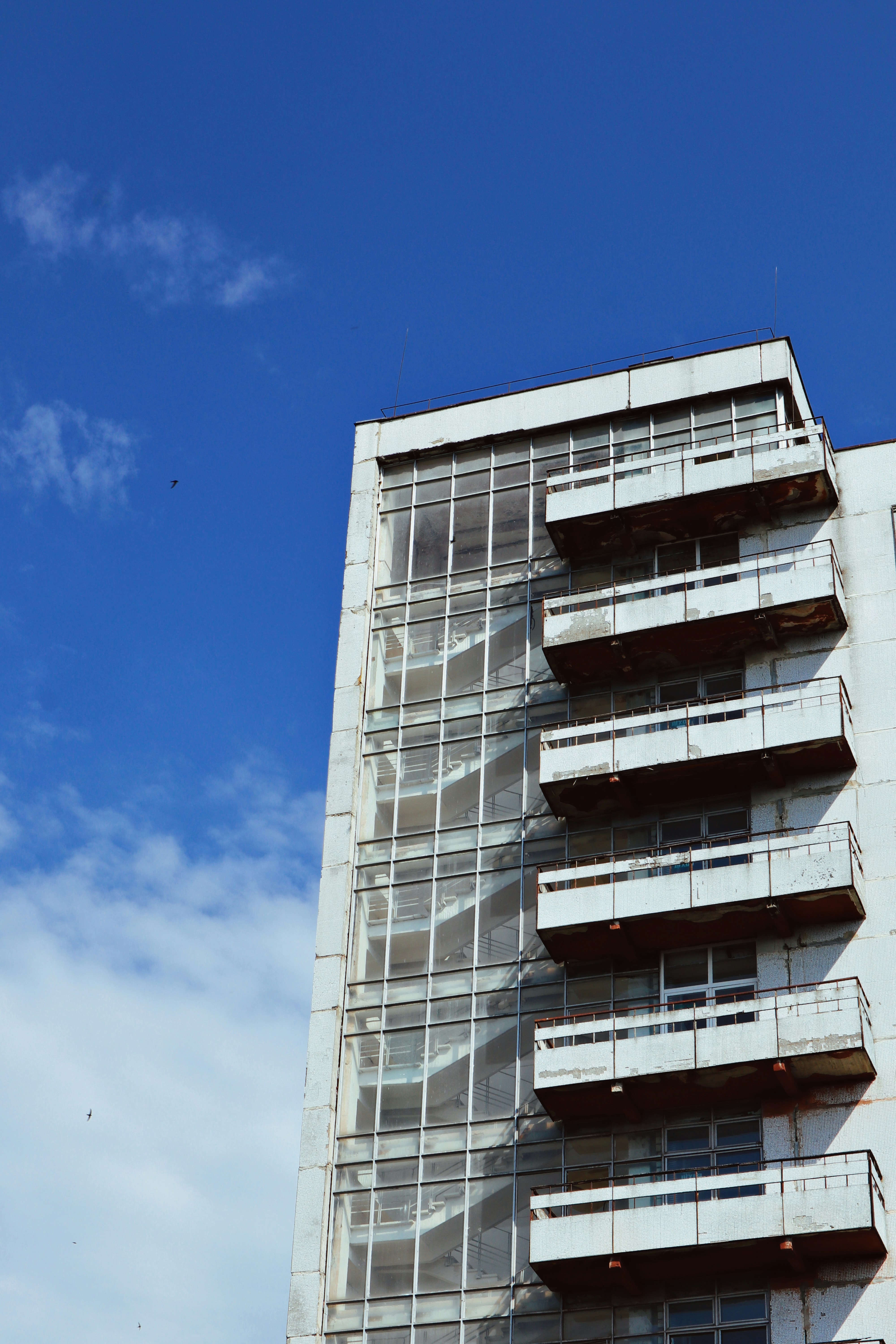 Vertical Concrete Echo: A High-Race Apartment Facade Against a Clear Sky