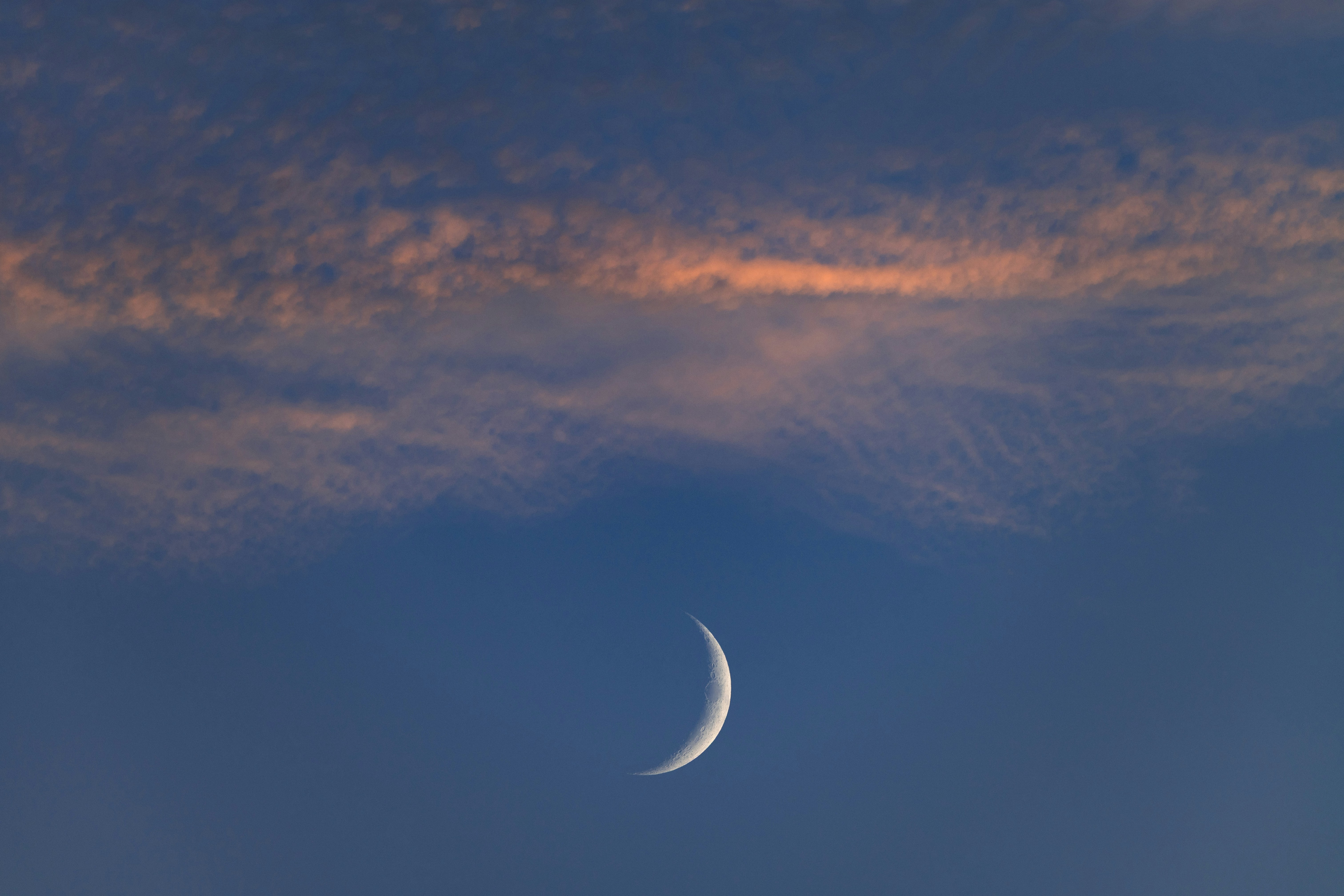 Crescent in Quiet Sky: A Lunar Pearl Above Dusk Clouds