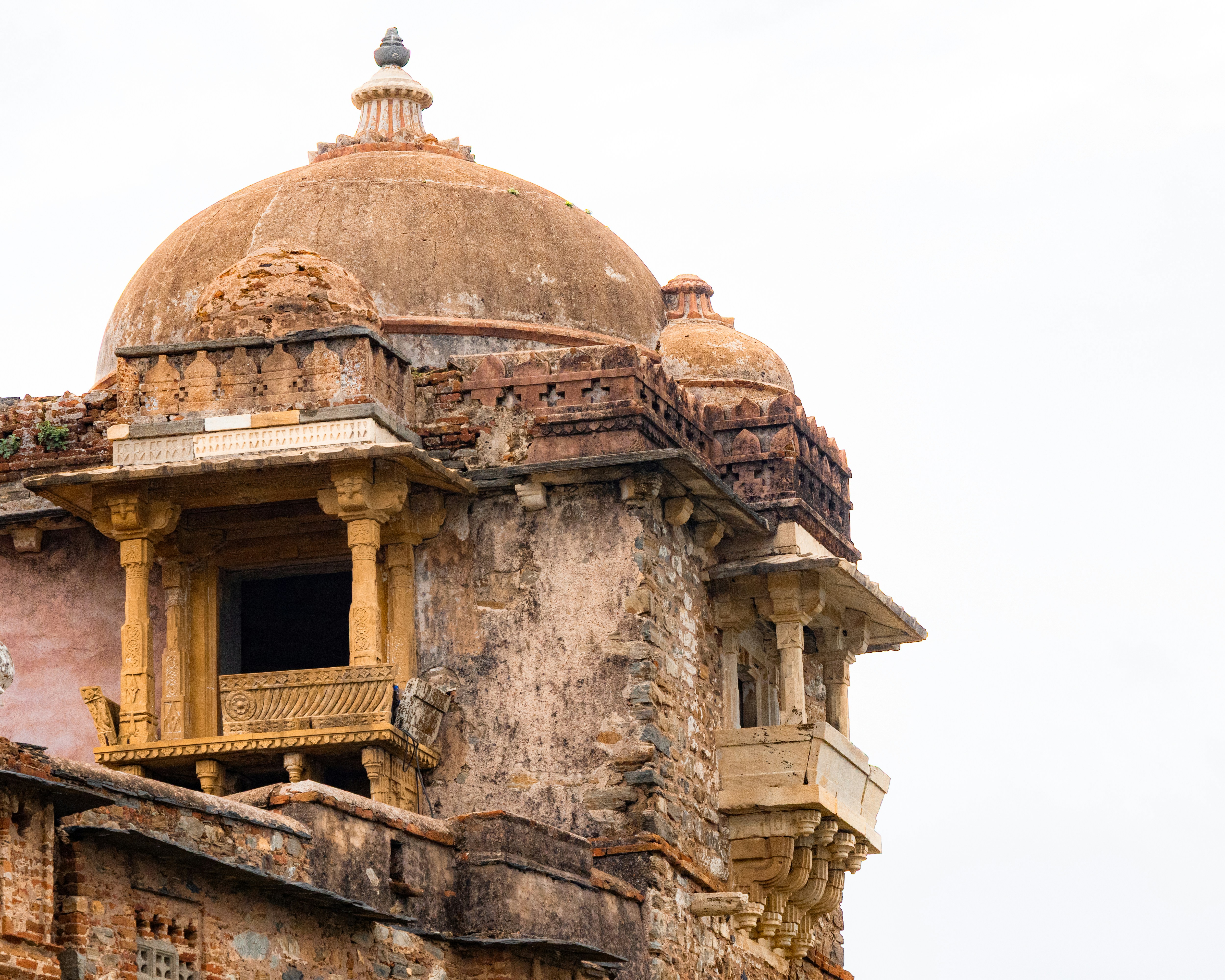 Weathered dome and carved balconies of a historic Indian fort