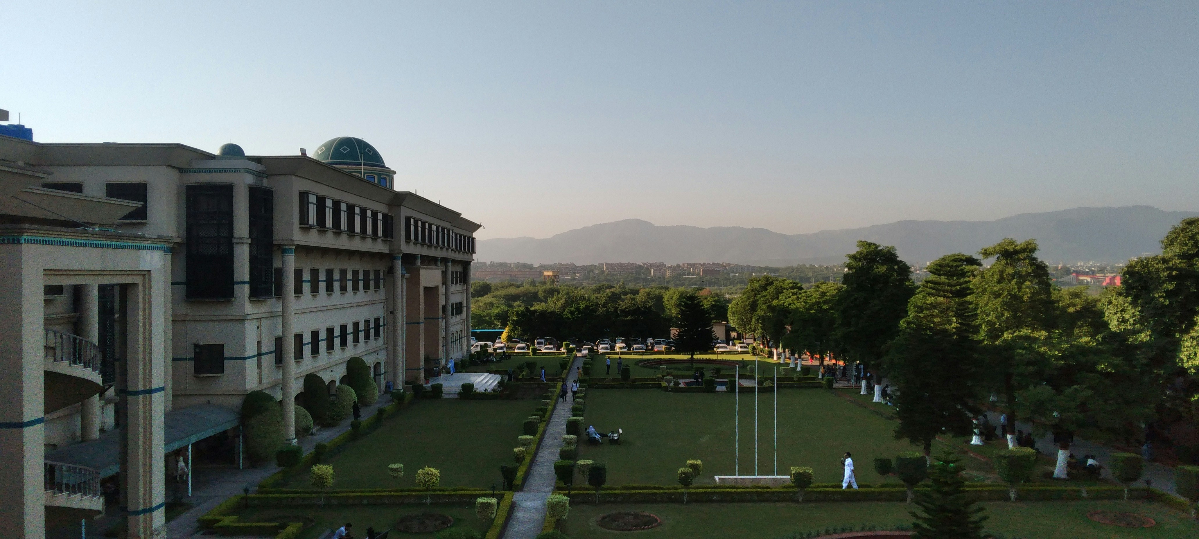 Campus Courtyard at Dusk: A Grand Building Framing a Quiet Lawn