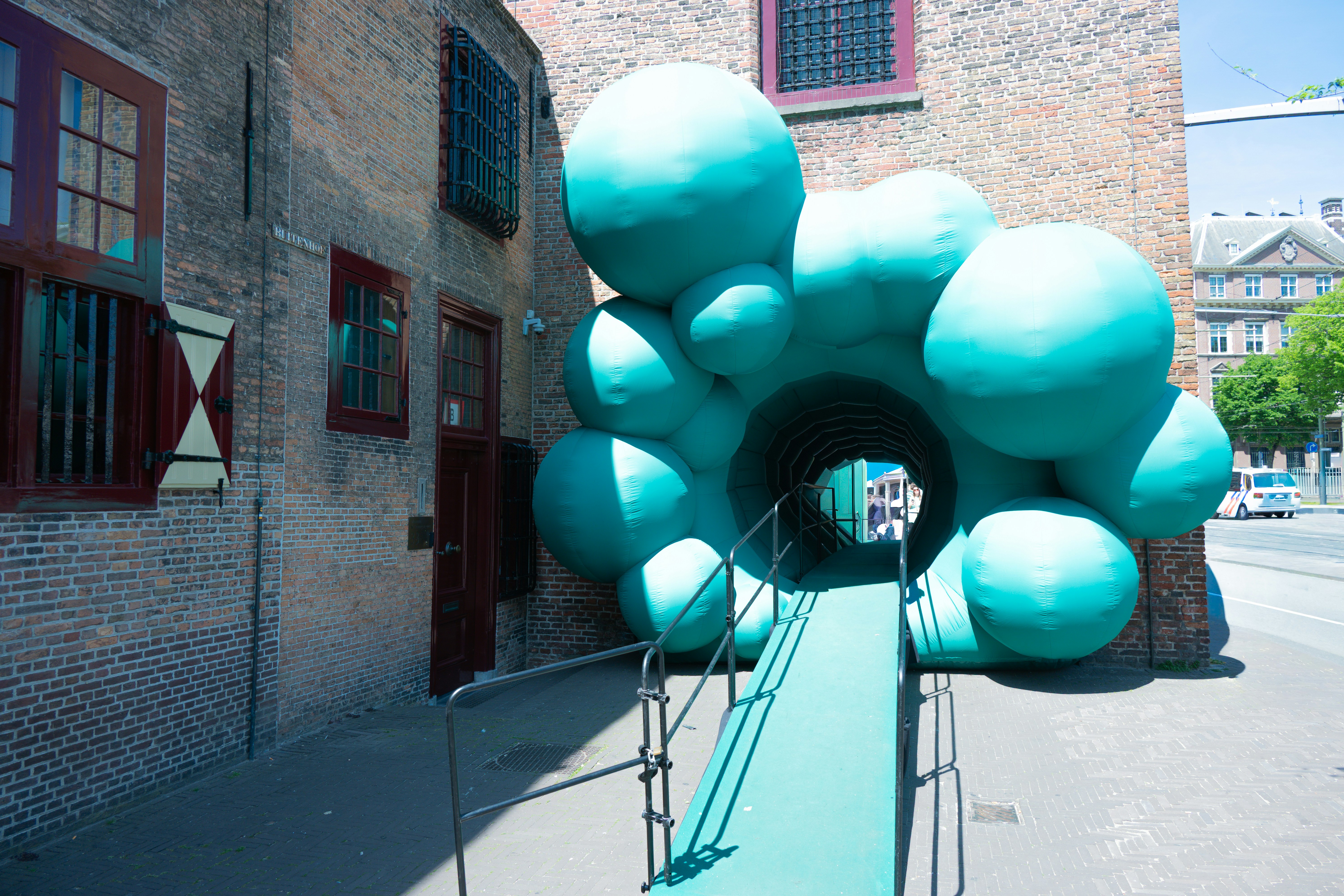 Teal Tunnel of Bubbles: A Playful Arcade to the Brick