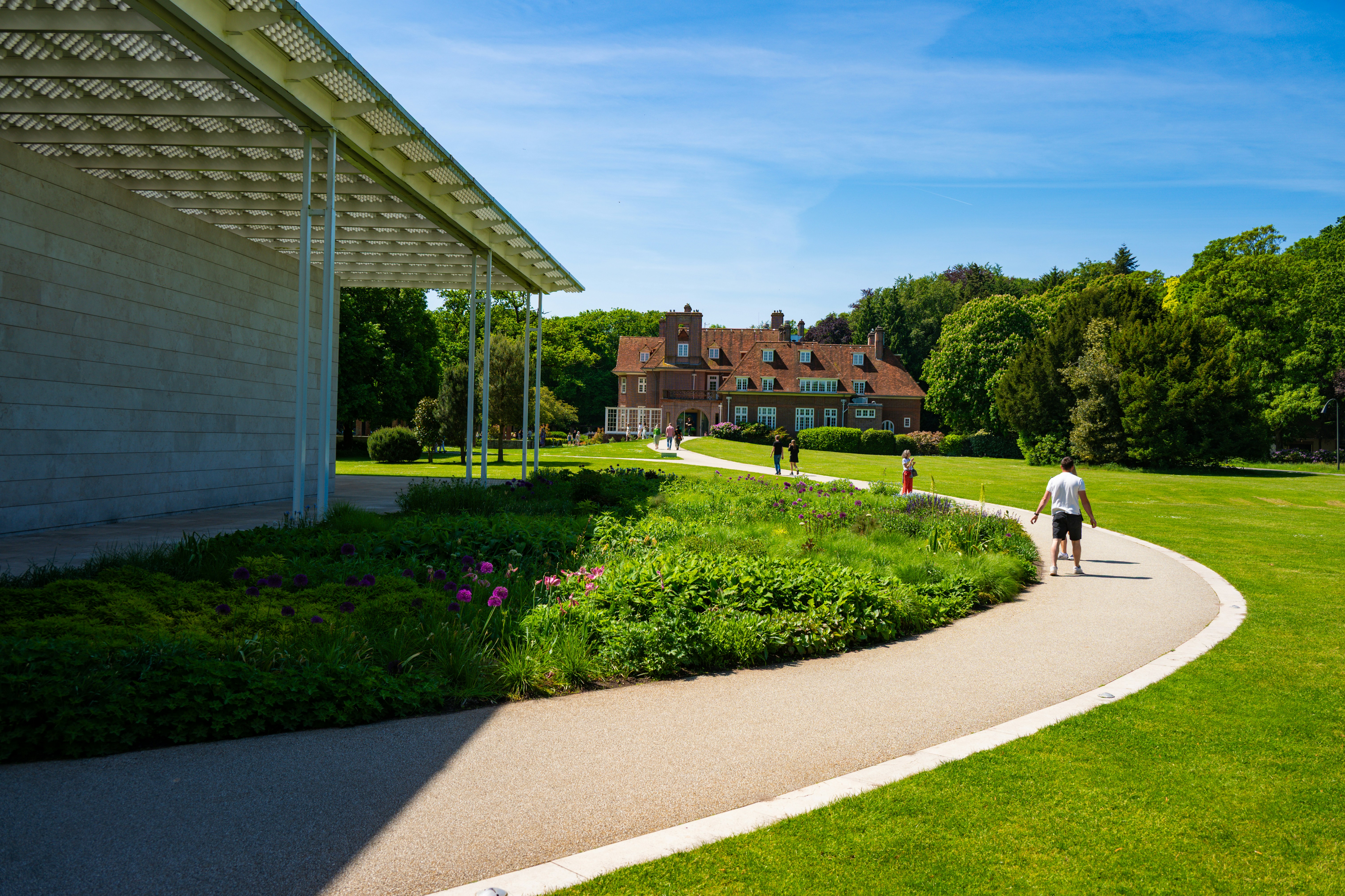 Curved Path Leading to a Historic Estate on a Bright Day