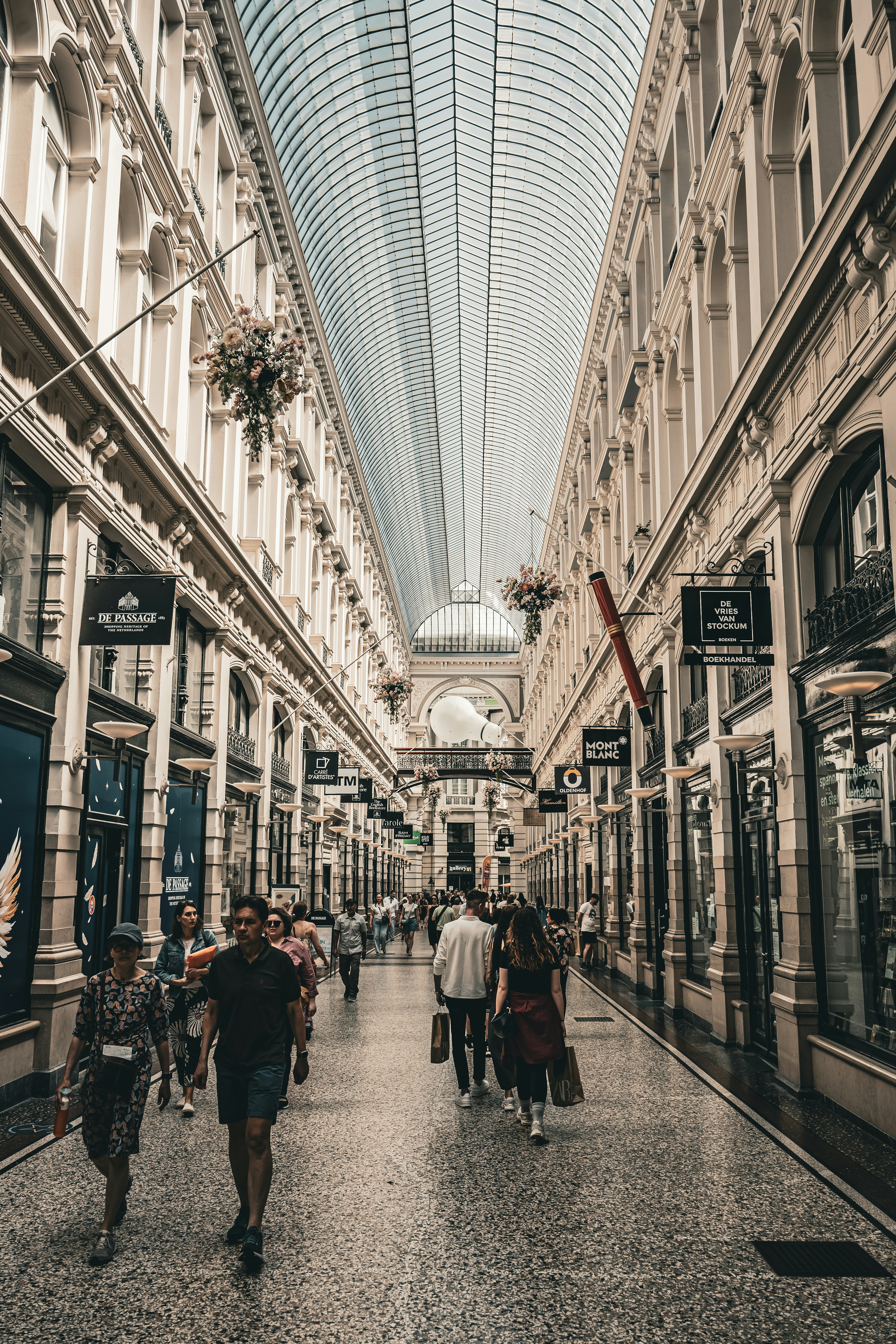 Gilded Gallery: A Sunlit Arcade of People and Arches
