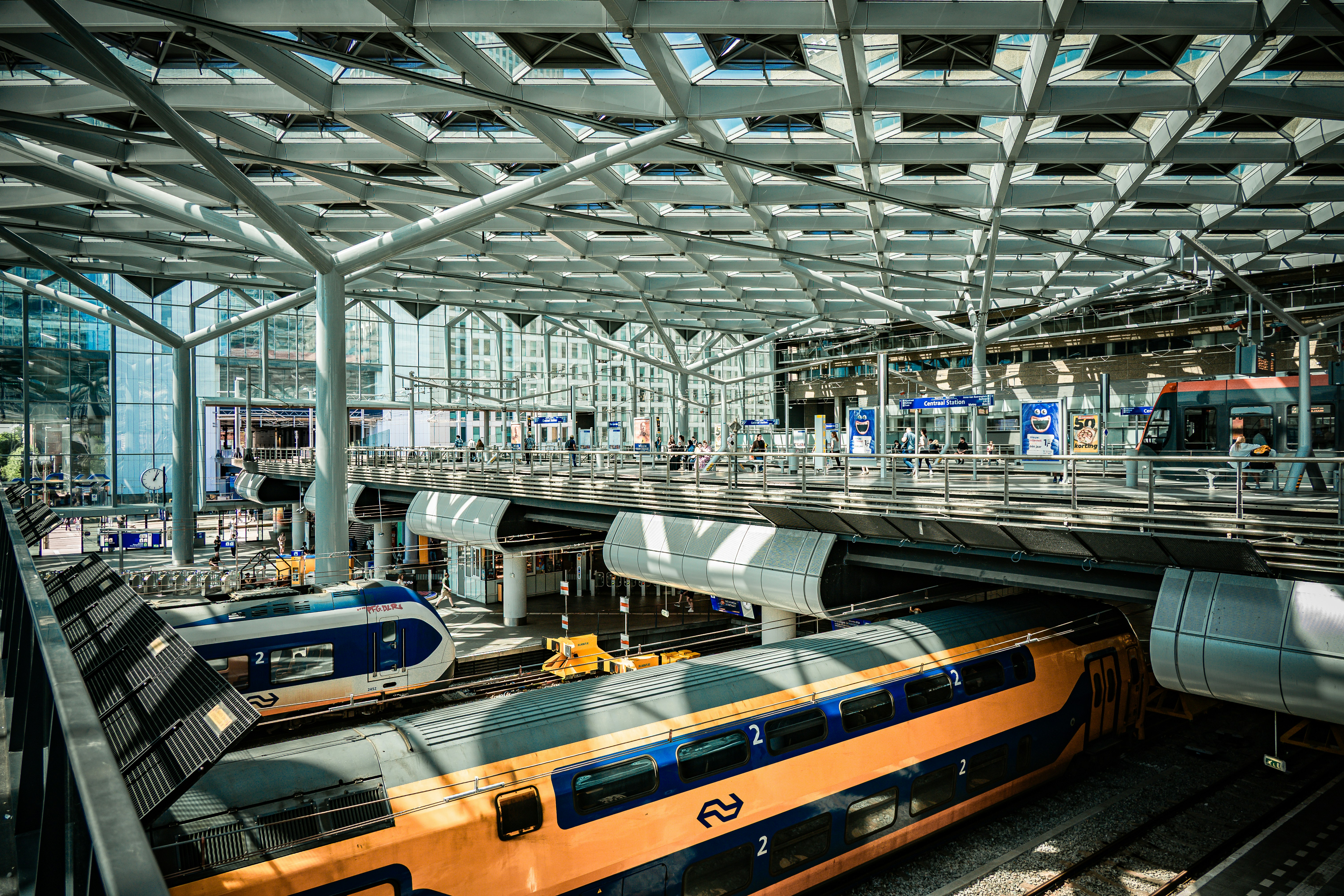 Sunlit Dutch Rail Hall: A Tranquil Moment Under Steel and Glass