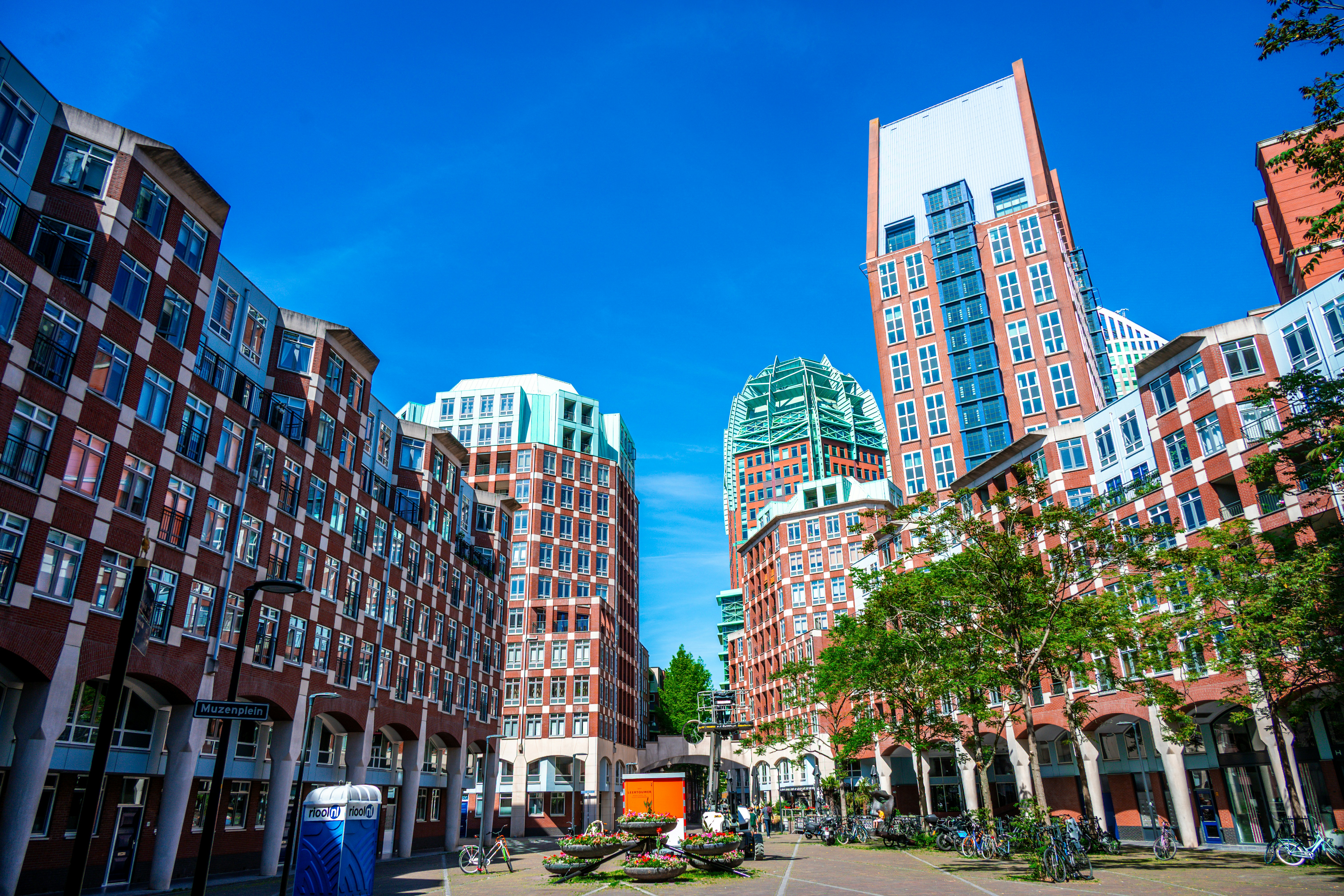 Cityscape Courtyard: Modern Brick Towers Rise Between Hardwood Walkways