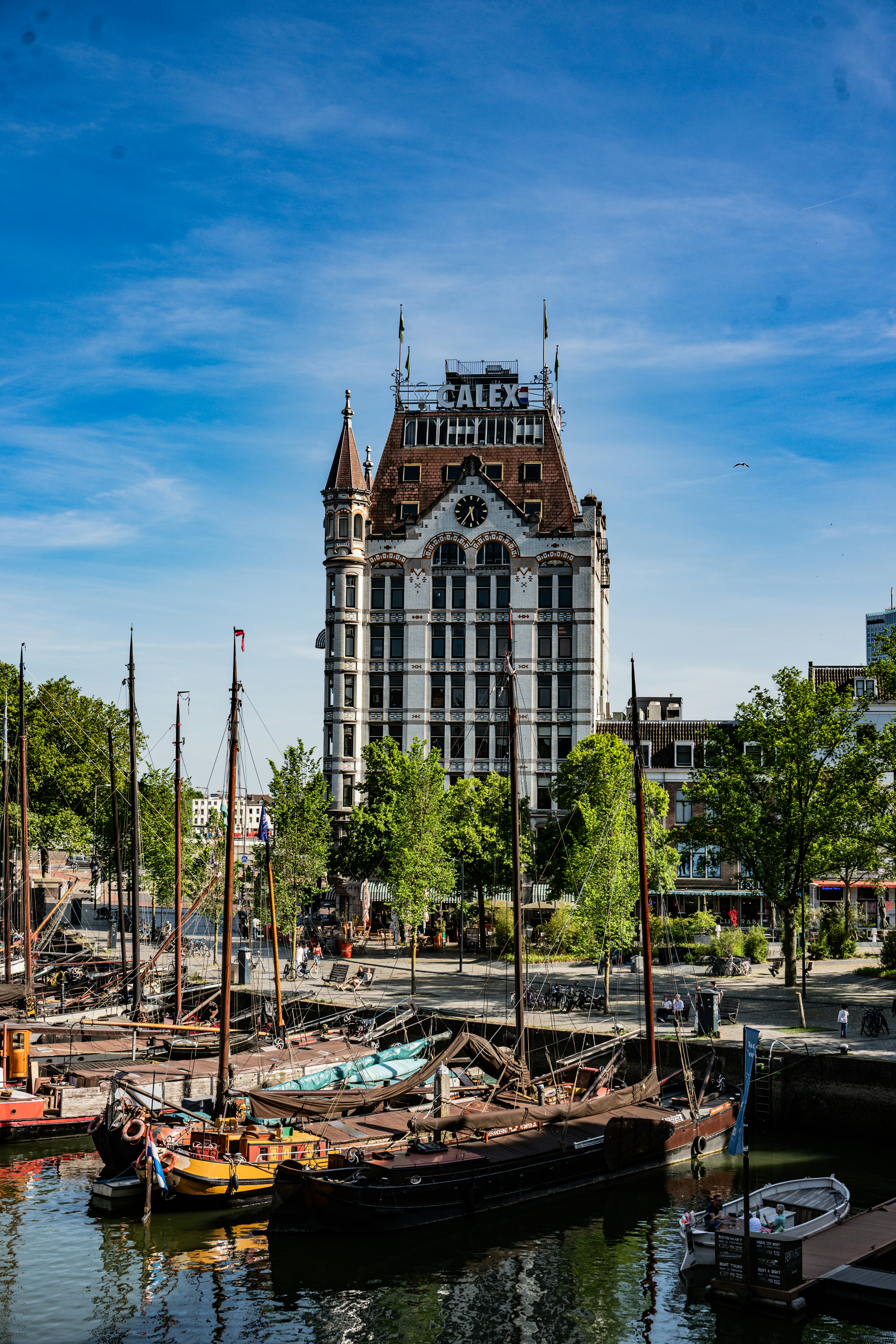 Harborfront Clocktower: Boats at Rest with a Gothic-Top Building
