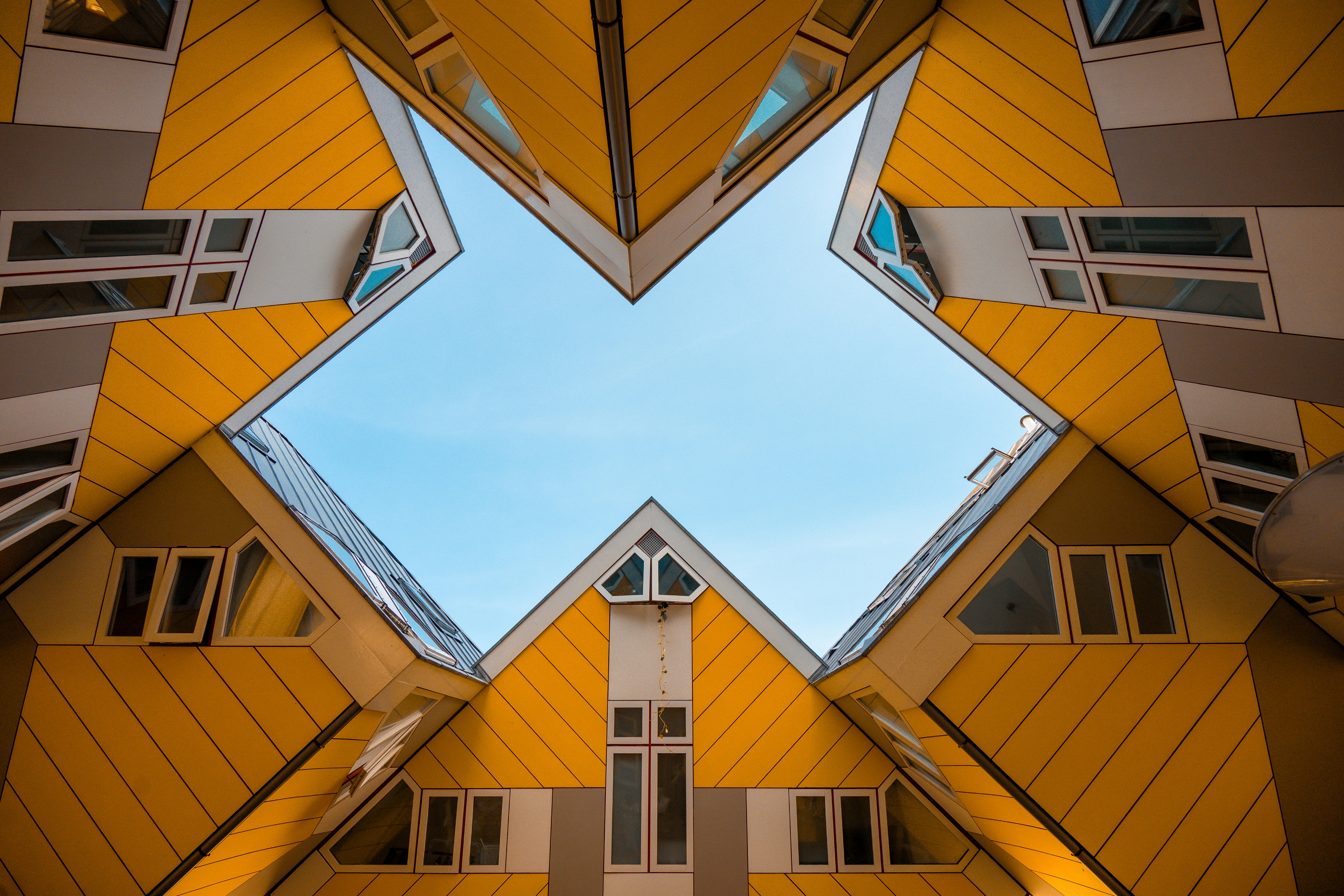 Yellow Angles: A Skyward View Through Delft’s Cubist Roofscape
