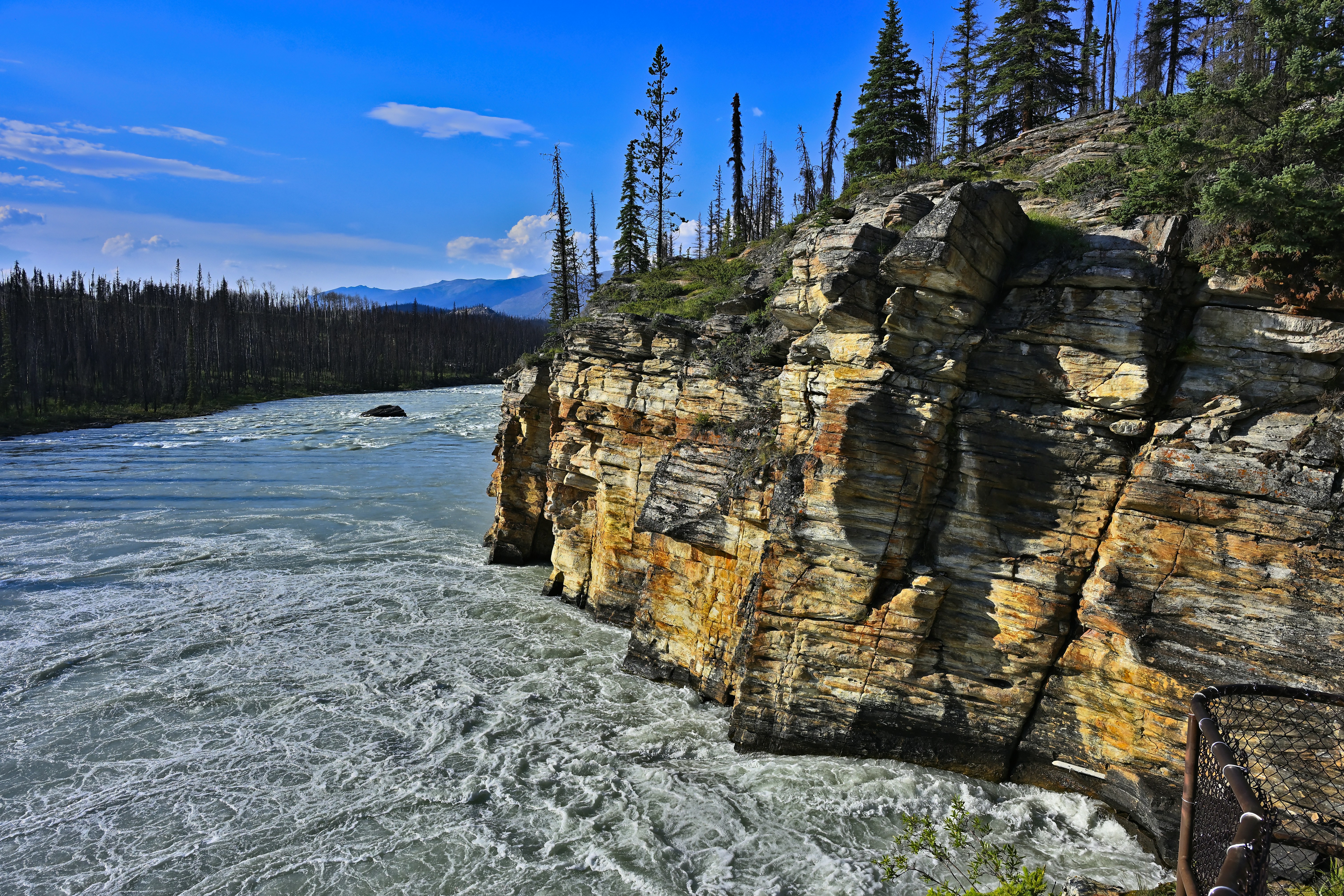 Rugged Cliffs Meet Glacial Waters: A Mountain River Standstill