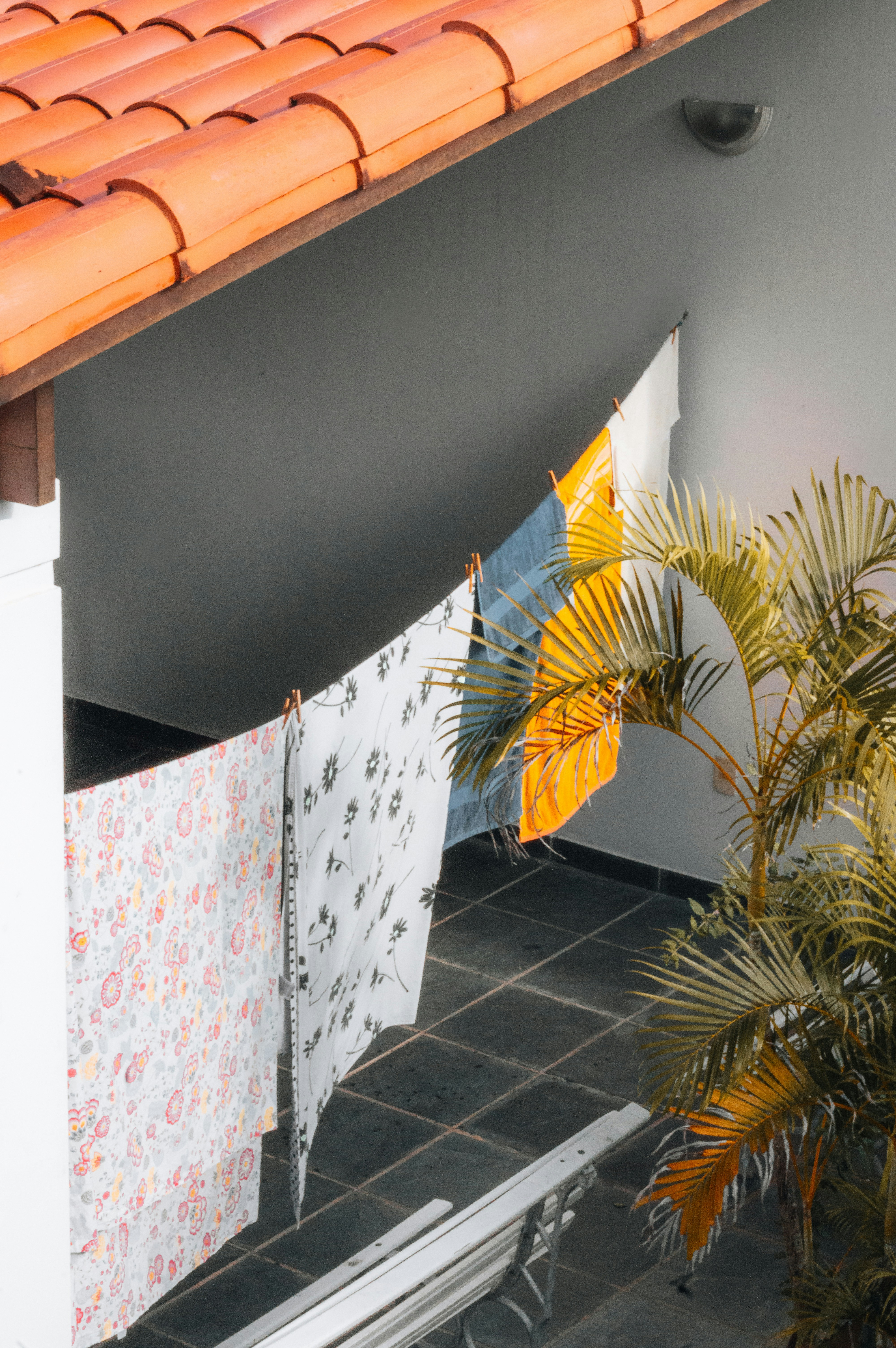 Sunlit Laundry Terrace: Draped Fabrics and Tropical Shadow