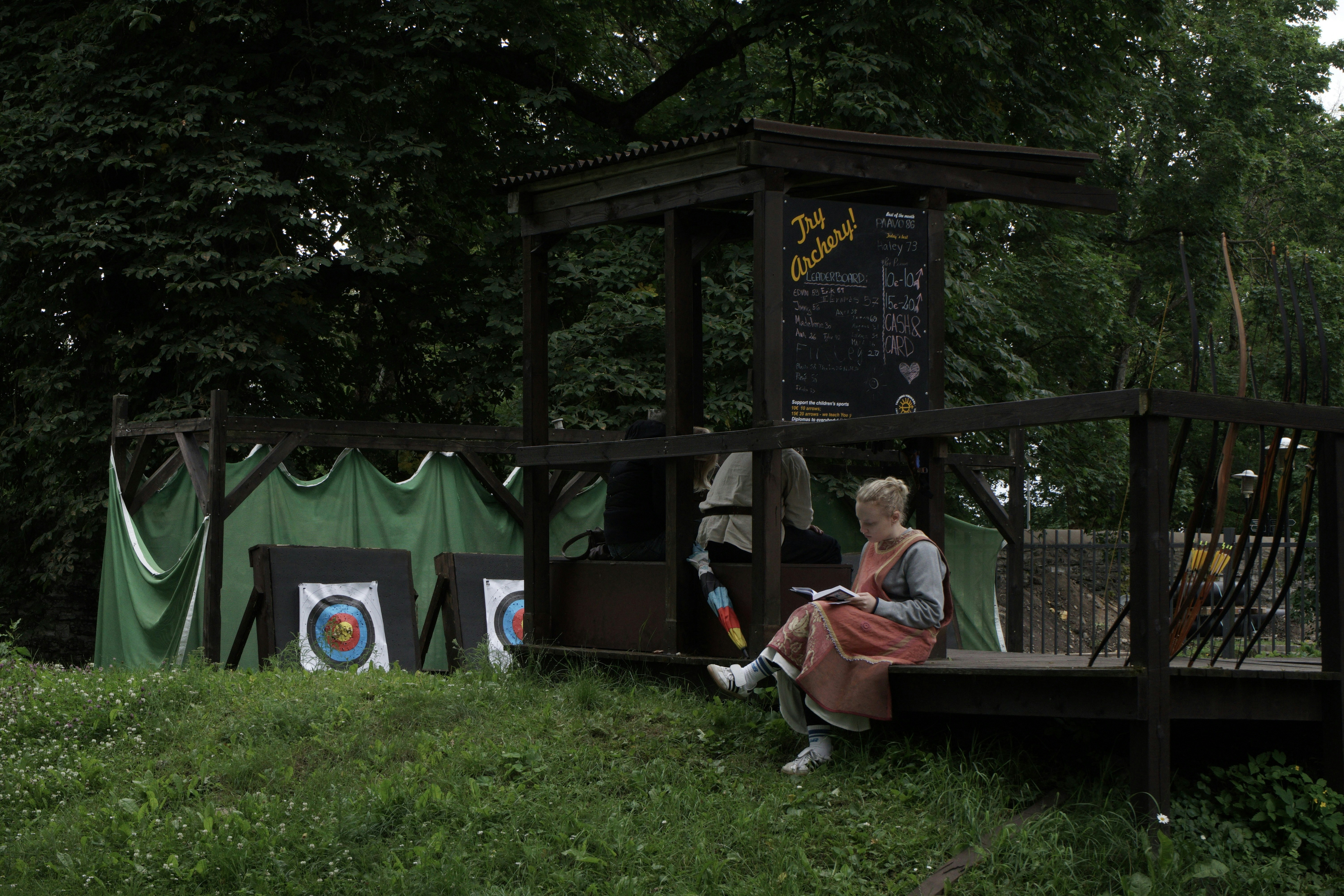 Quiet Moment at the Archery Range: A Woman Reads on the Platform