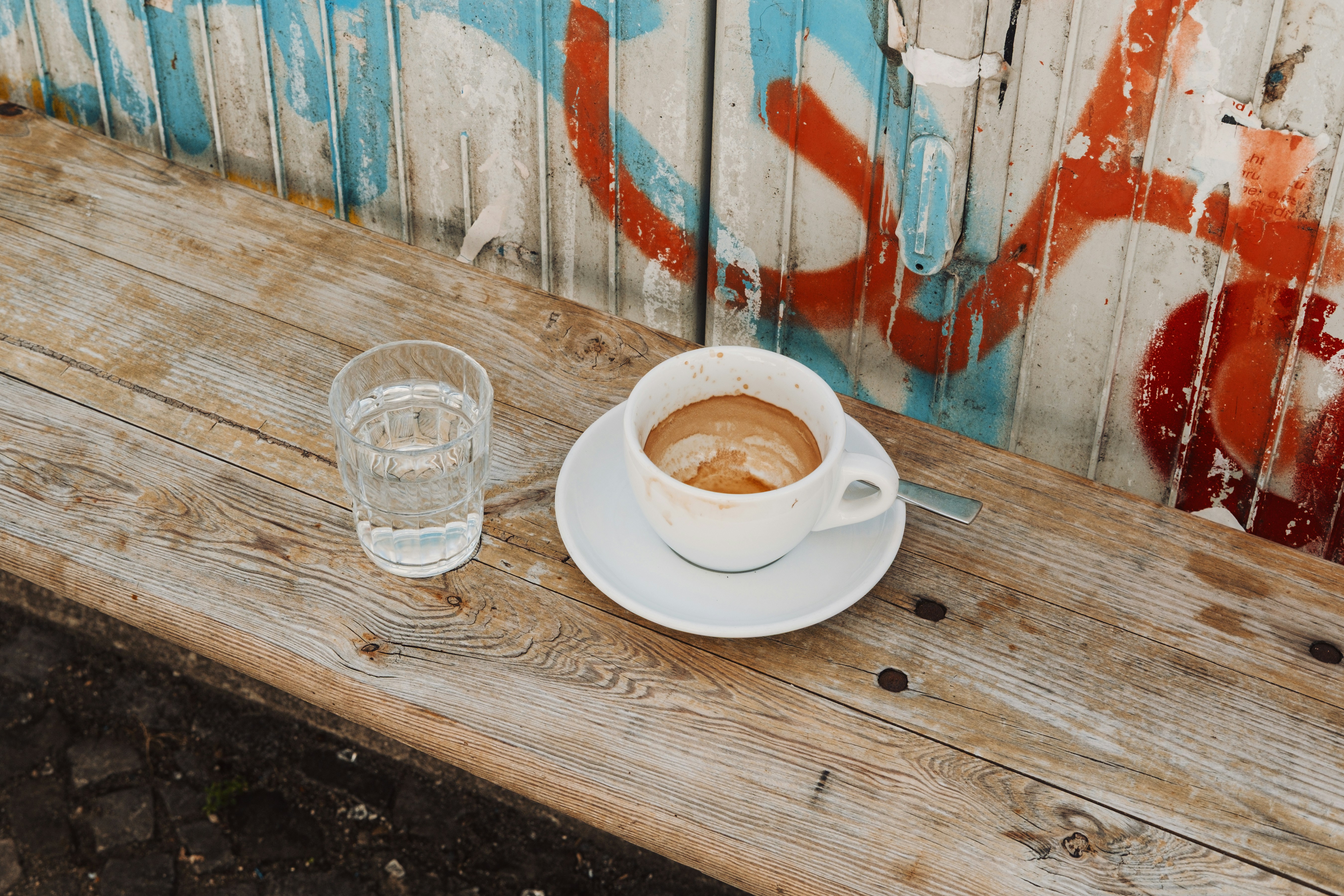 Cup of Warmth on a Graffiti Bench