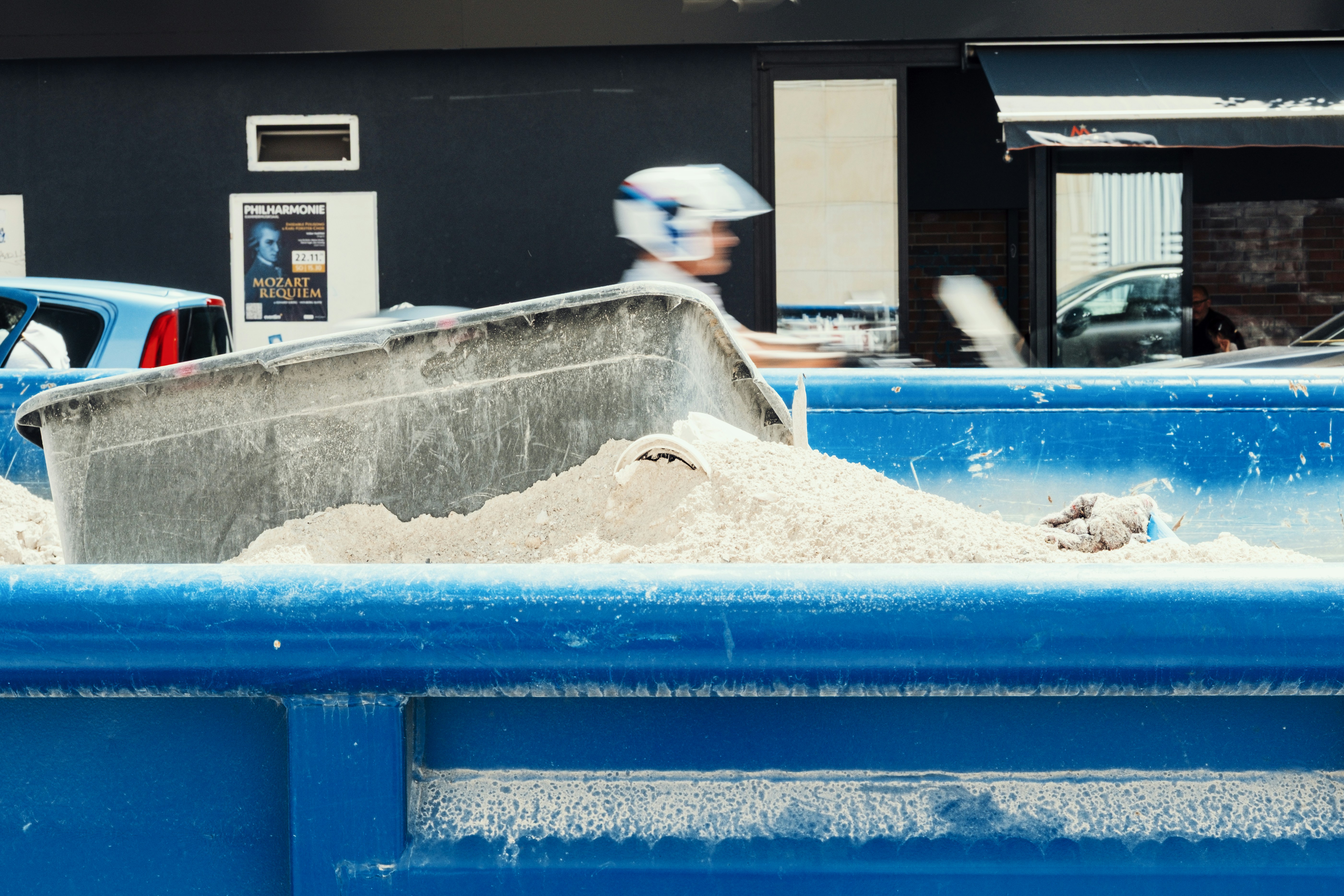 Dumpsters and Sand: A Busy City Scene Painted in Blue